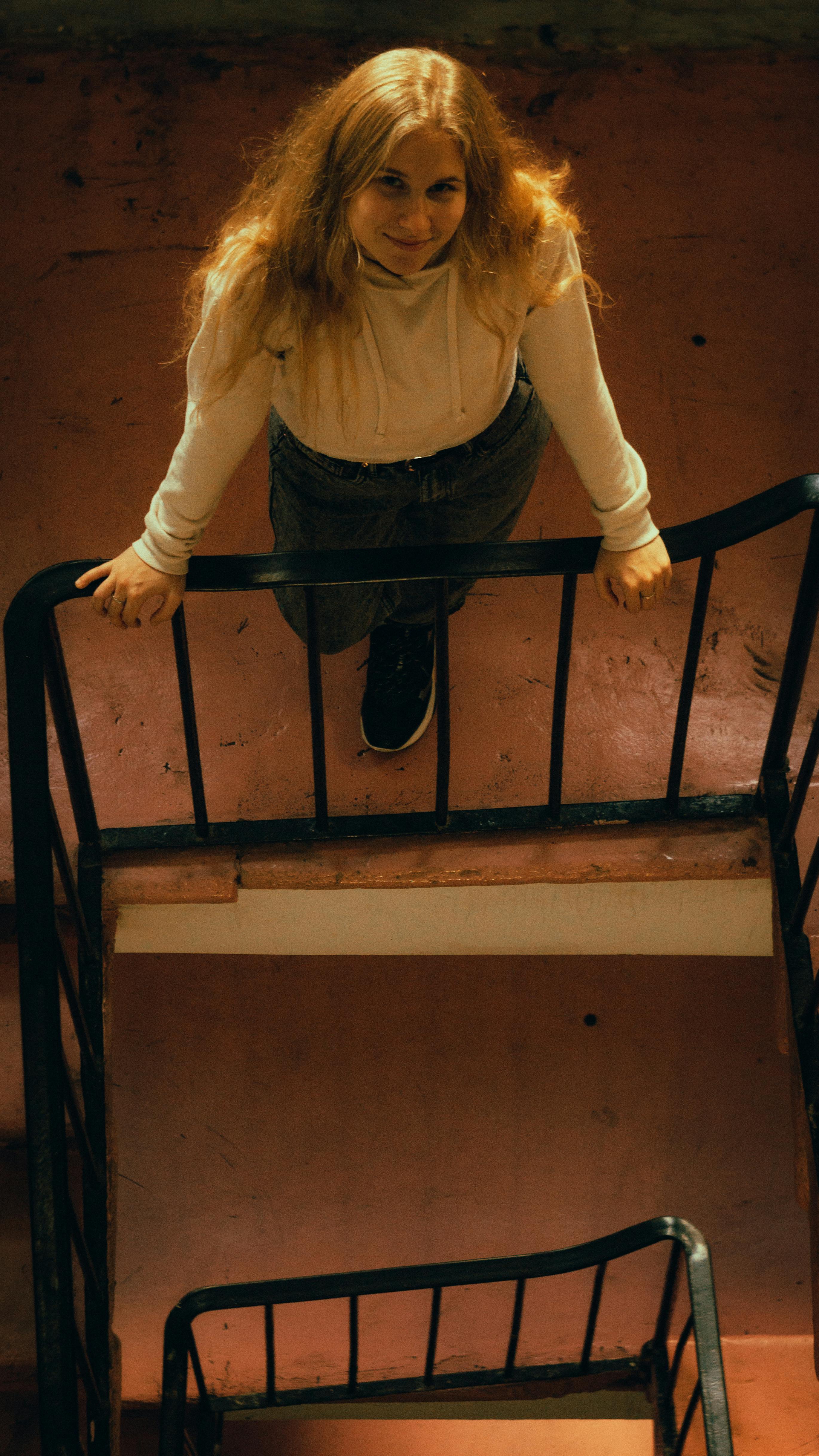 Woman in White Long Sleeves Holding a Sketchpad · Free Stock Photo