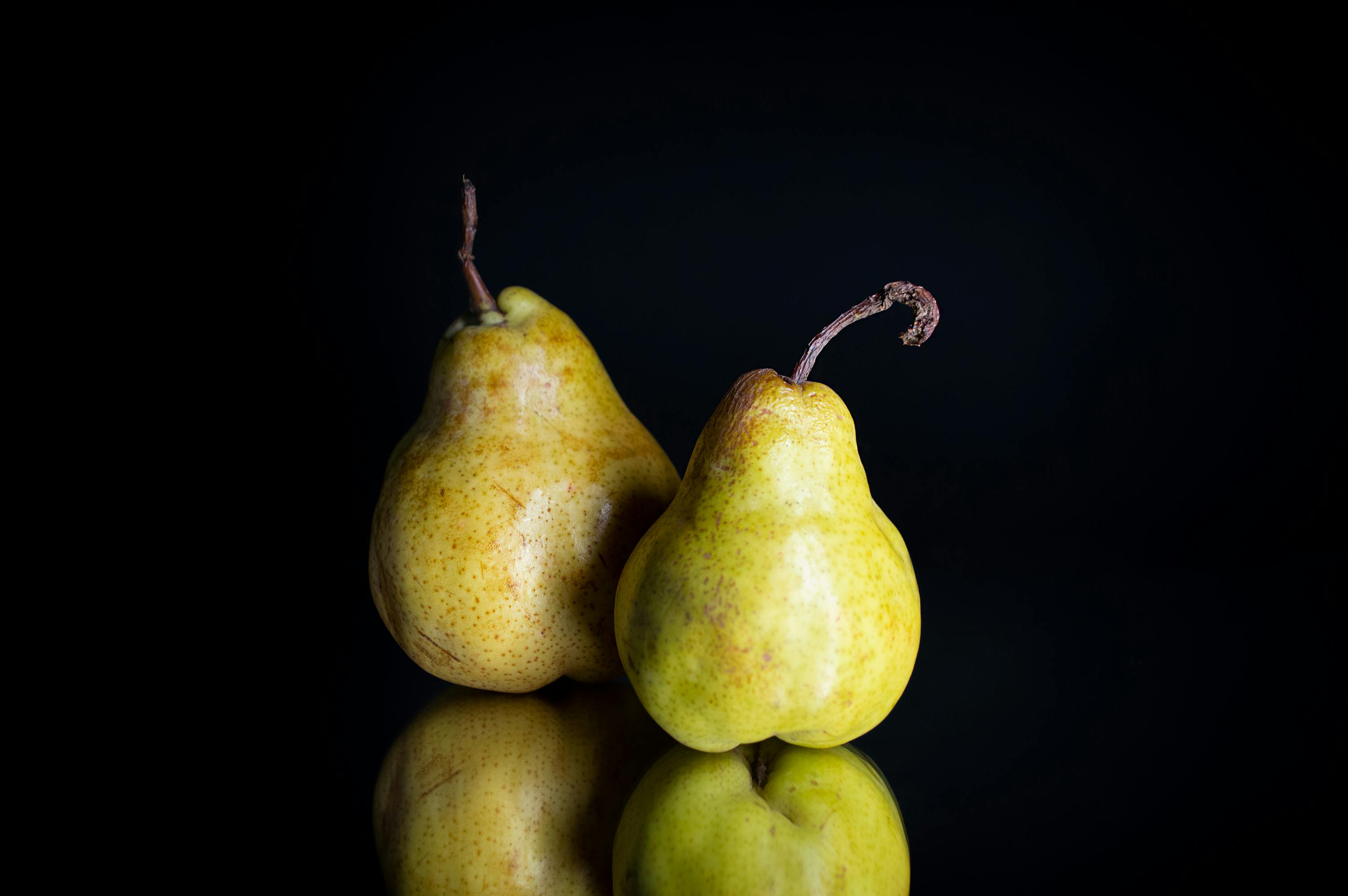 Photo of Two Pears with Brown Stems · Free Stock Photo