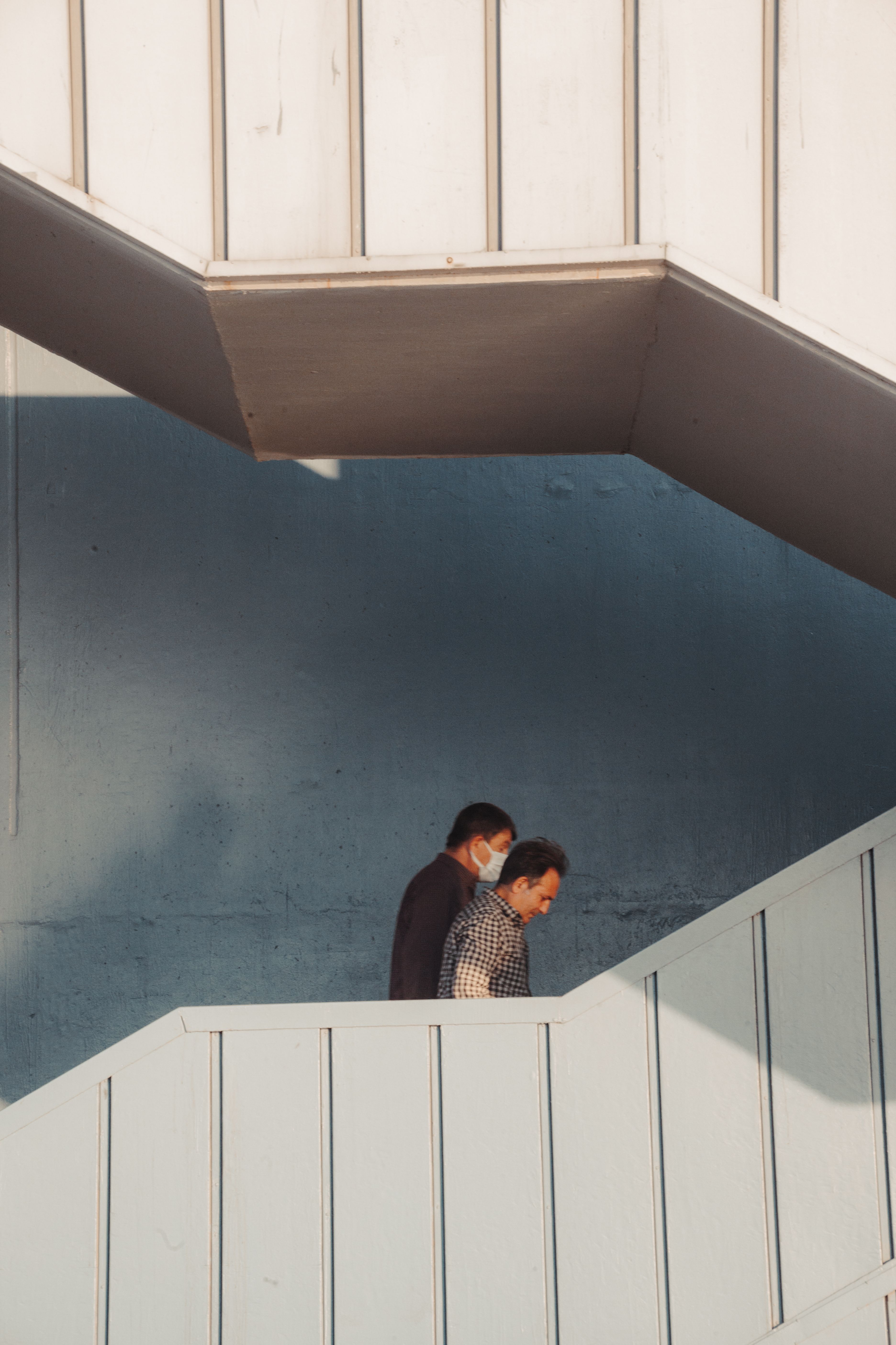 Men Walking on the Stairs on White Concrete Building · Free Stock Photo