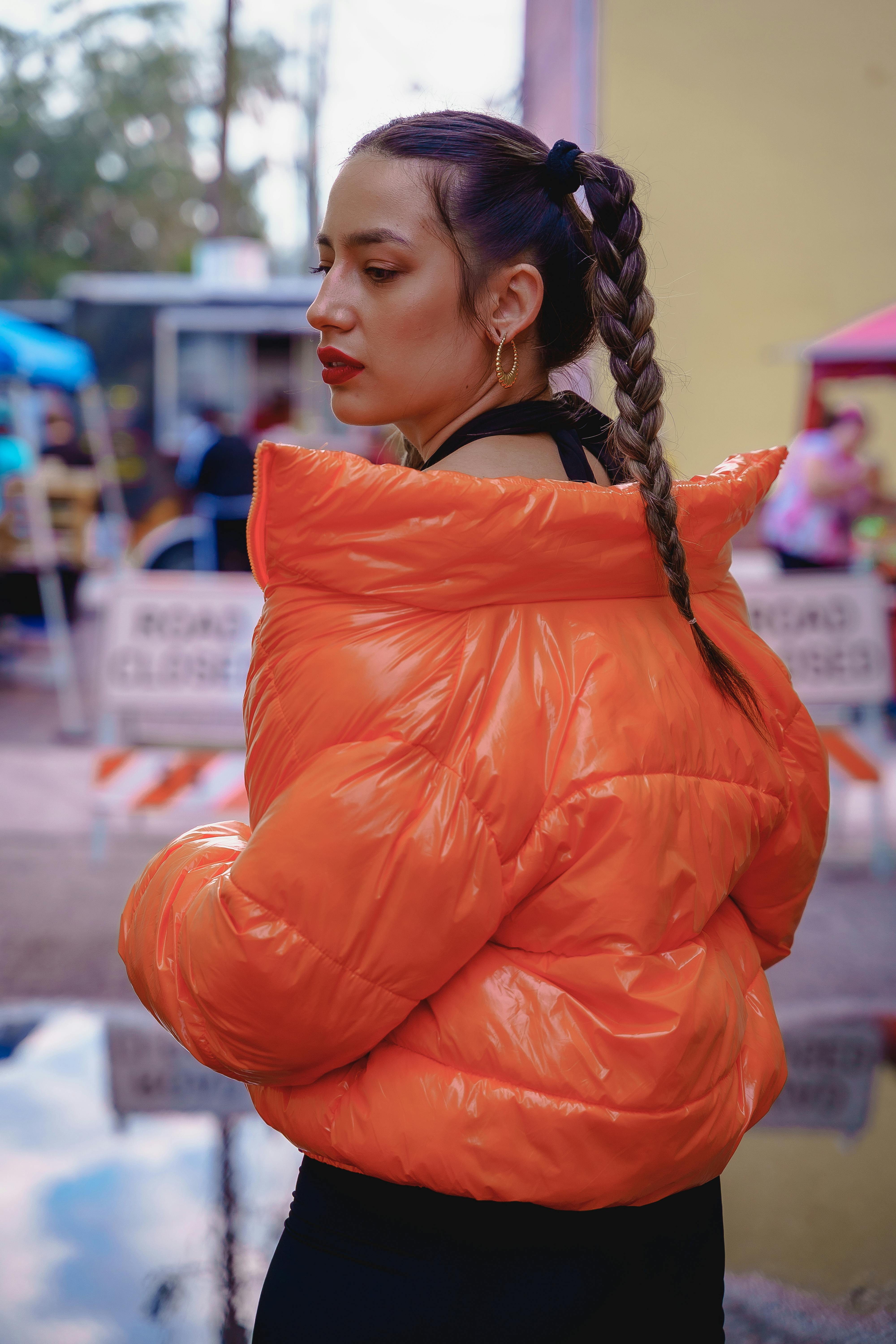 Woman in Orange Bubble Jacket · Free Stock Photo