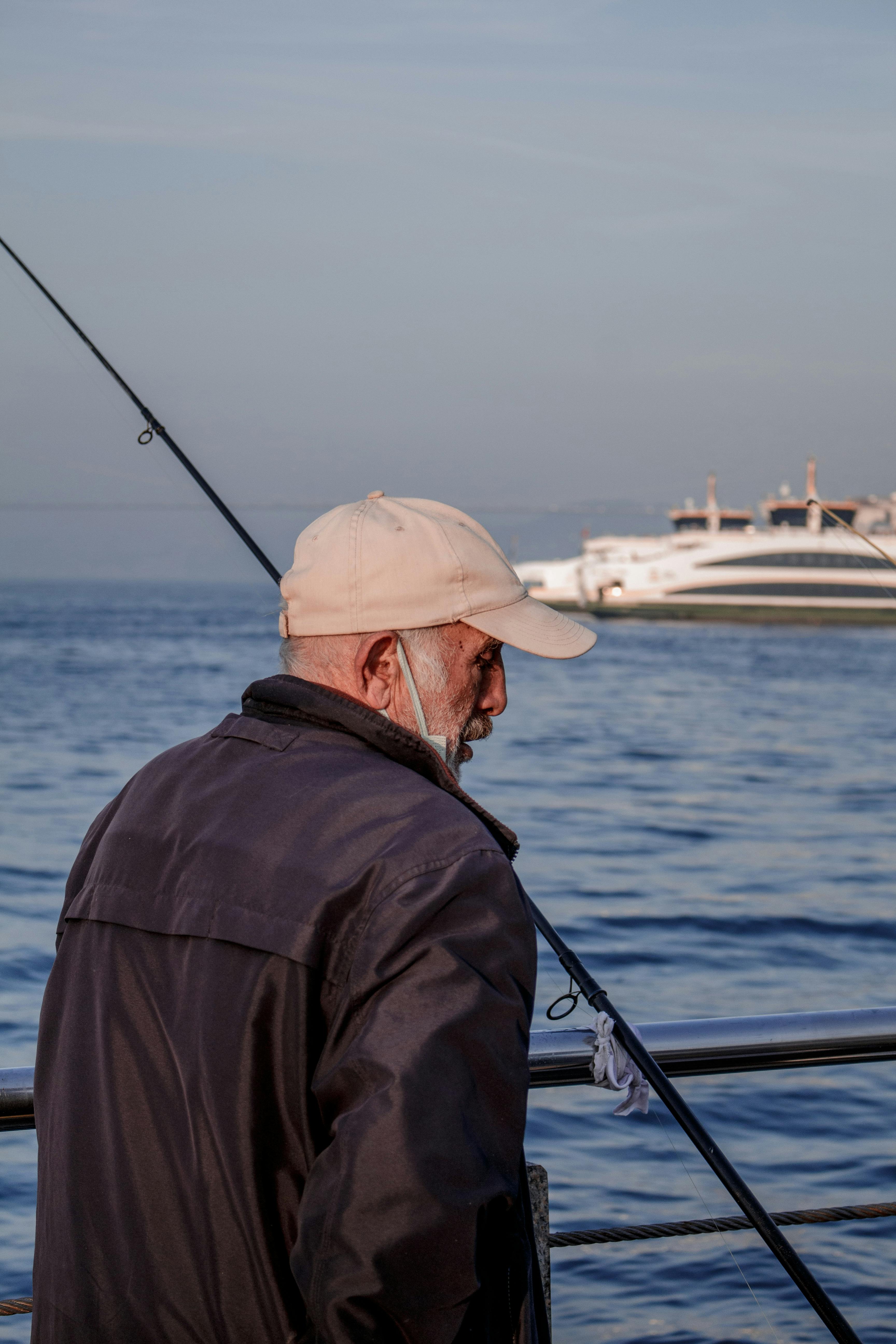 Elderly Man Fishing in Sea · Free Stock Photo