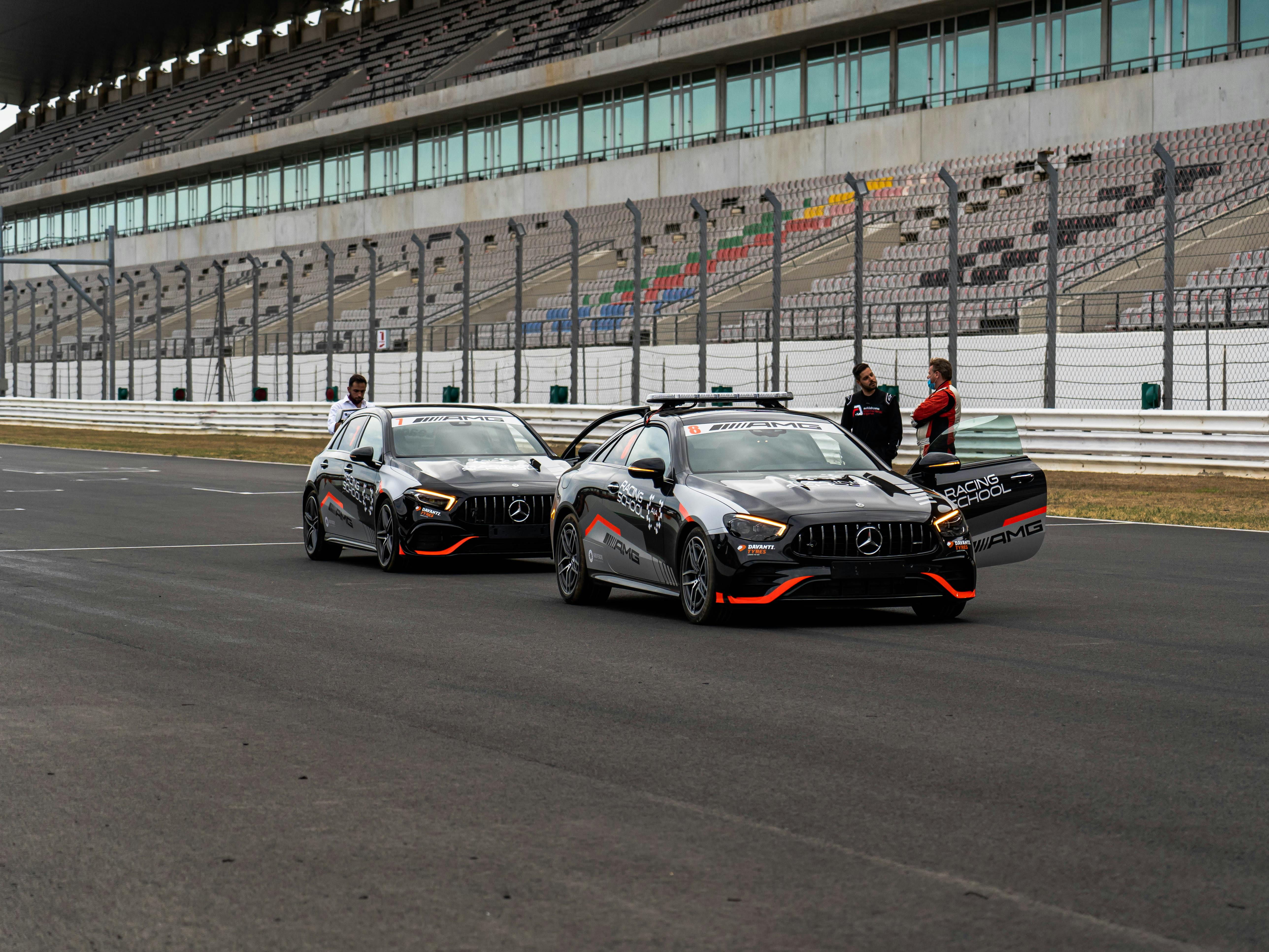 Black Cars Parked on Asphalt Road in a Racing Track · Free Stock Photo