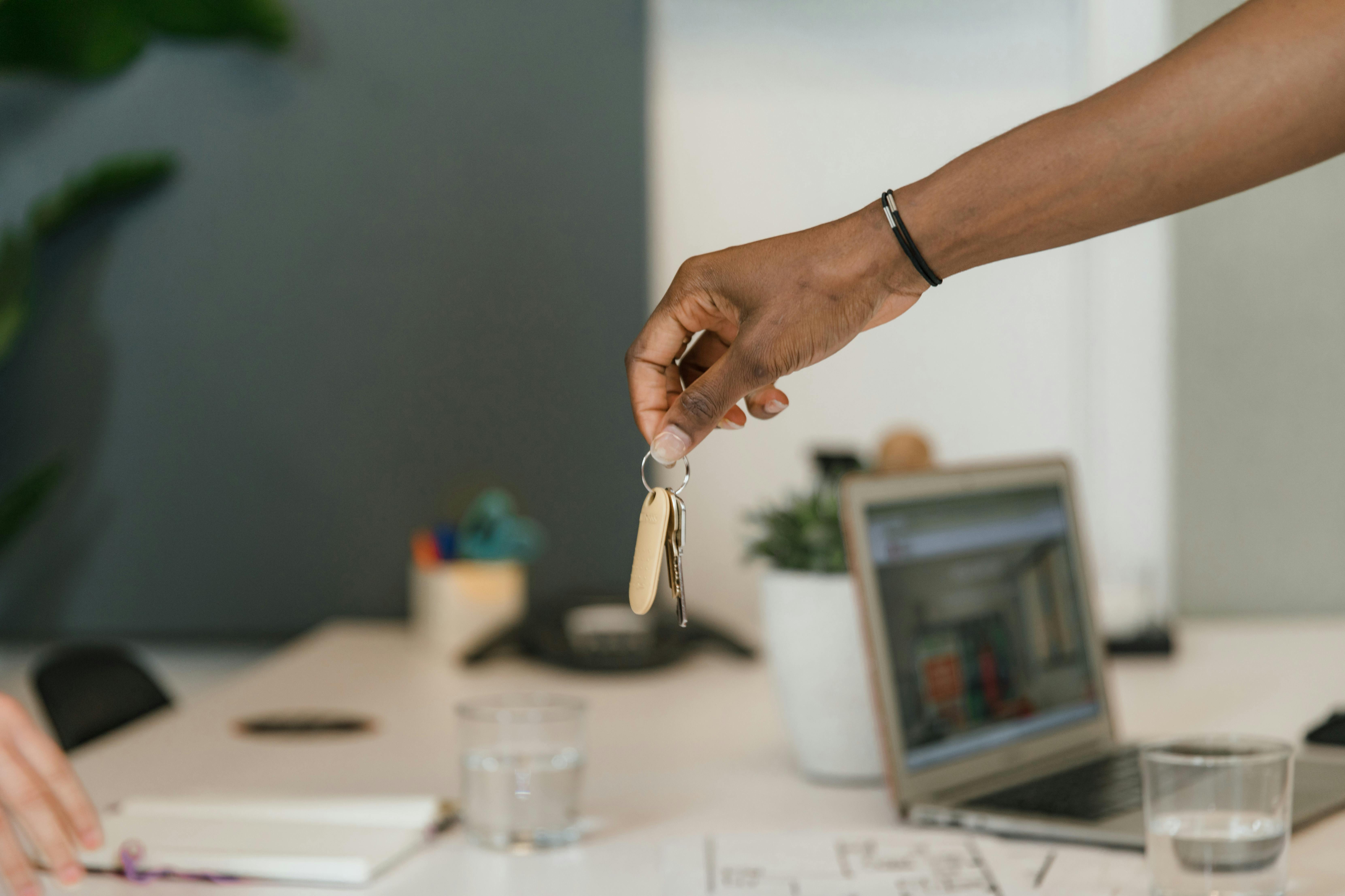Person Handling Keys in Office · Free Stock Photo