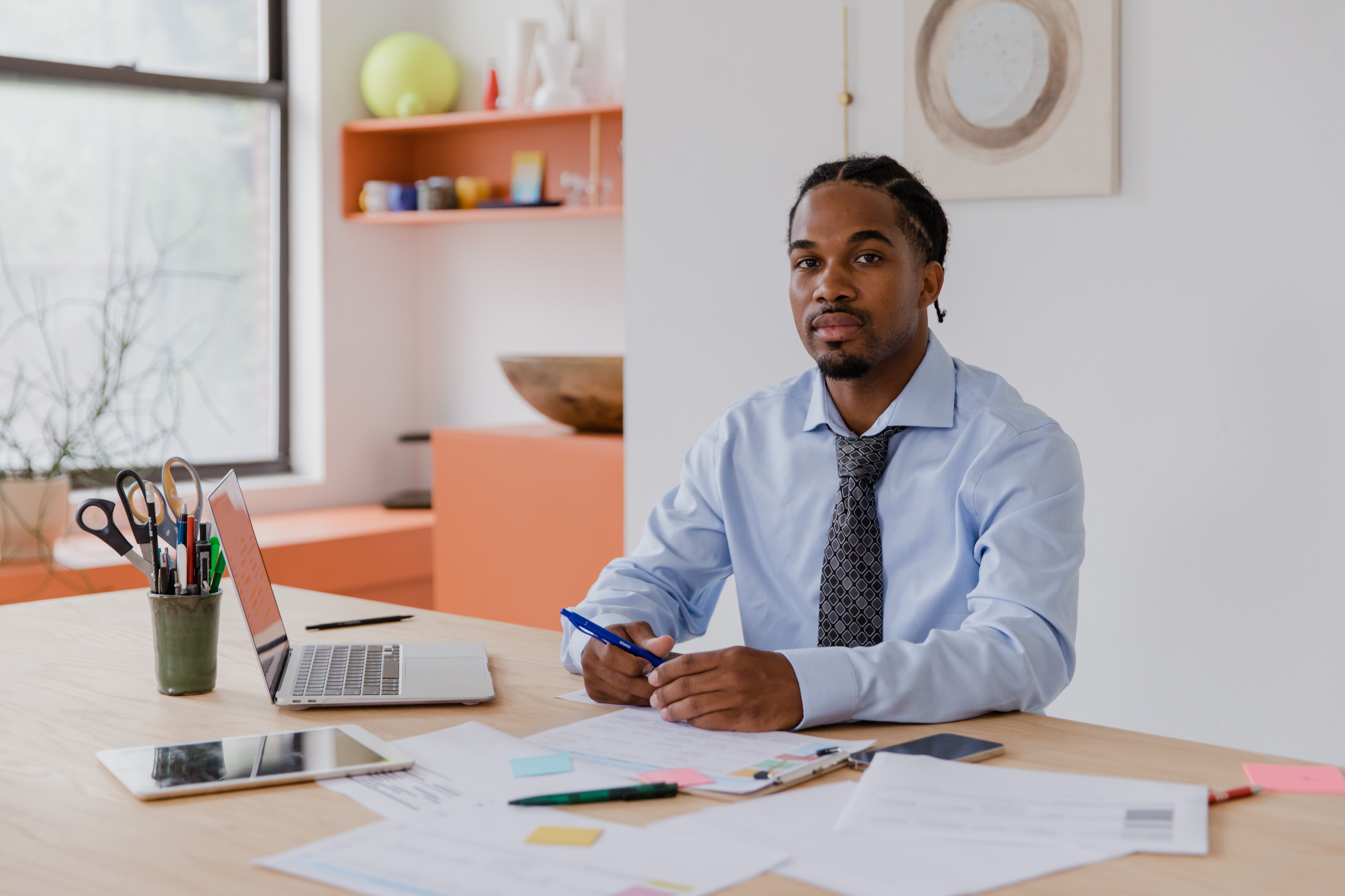 Man Standing Next to Desk · Free Stock Photo