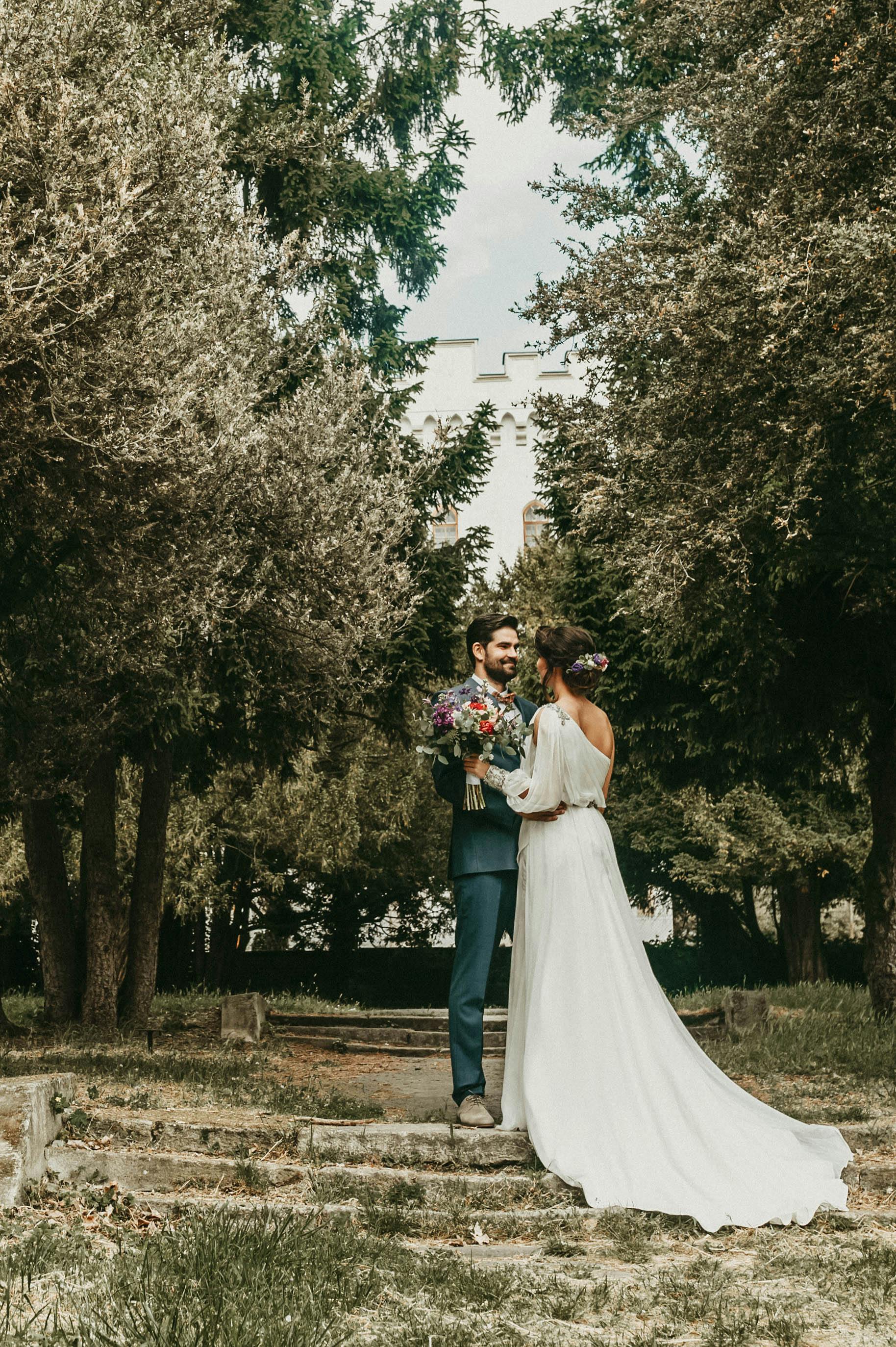 Bride and Groom Doing a Photoshoot in the Rain · Free Stock Photo