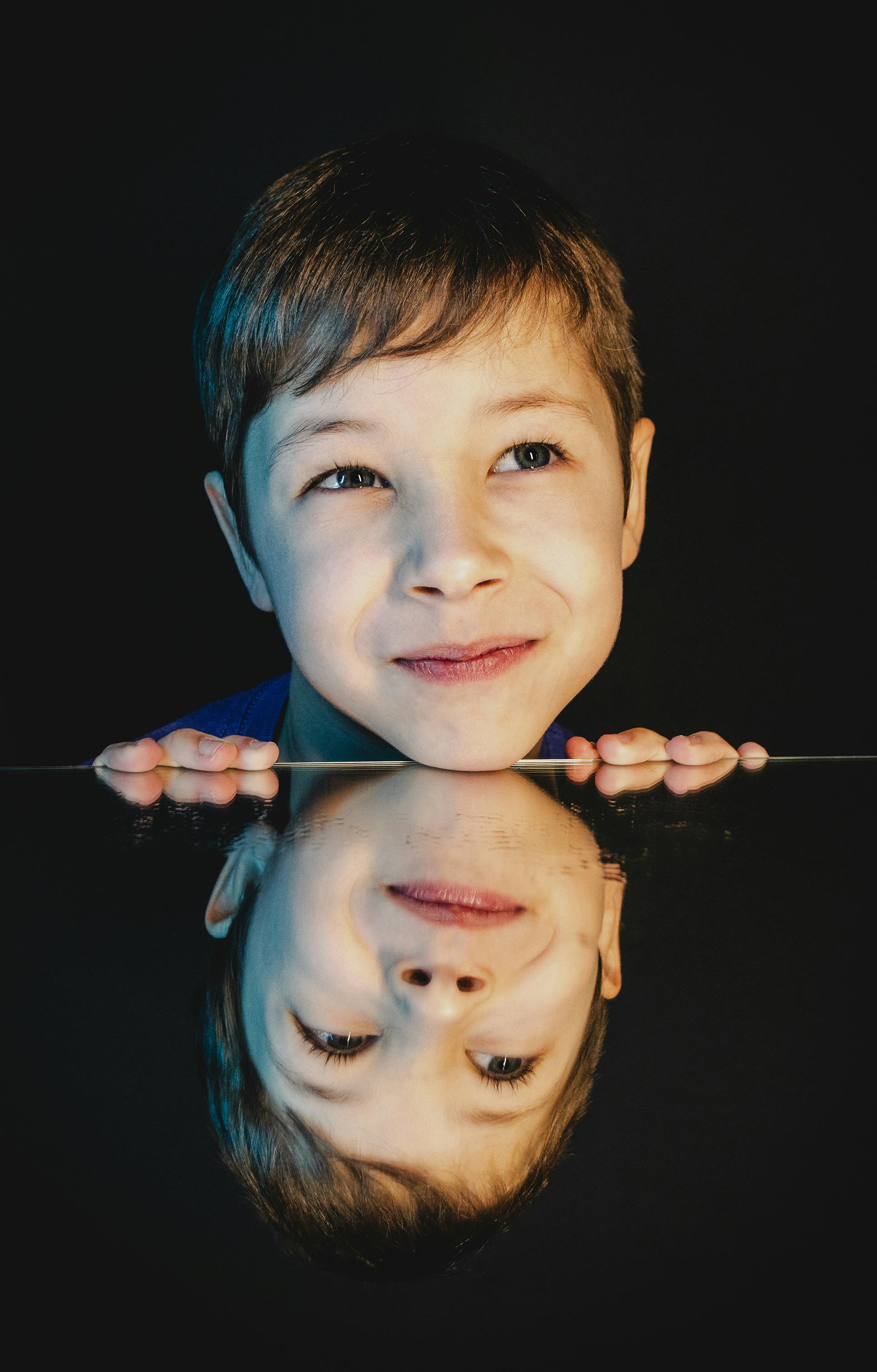 A Boy with Reflection on Glass Table · Free Stock Photo