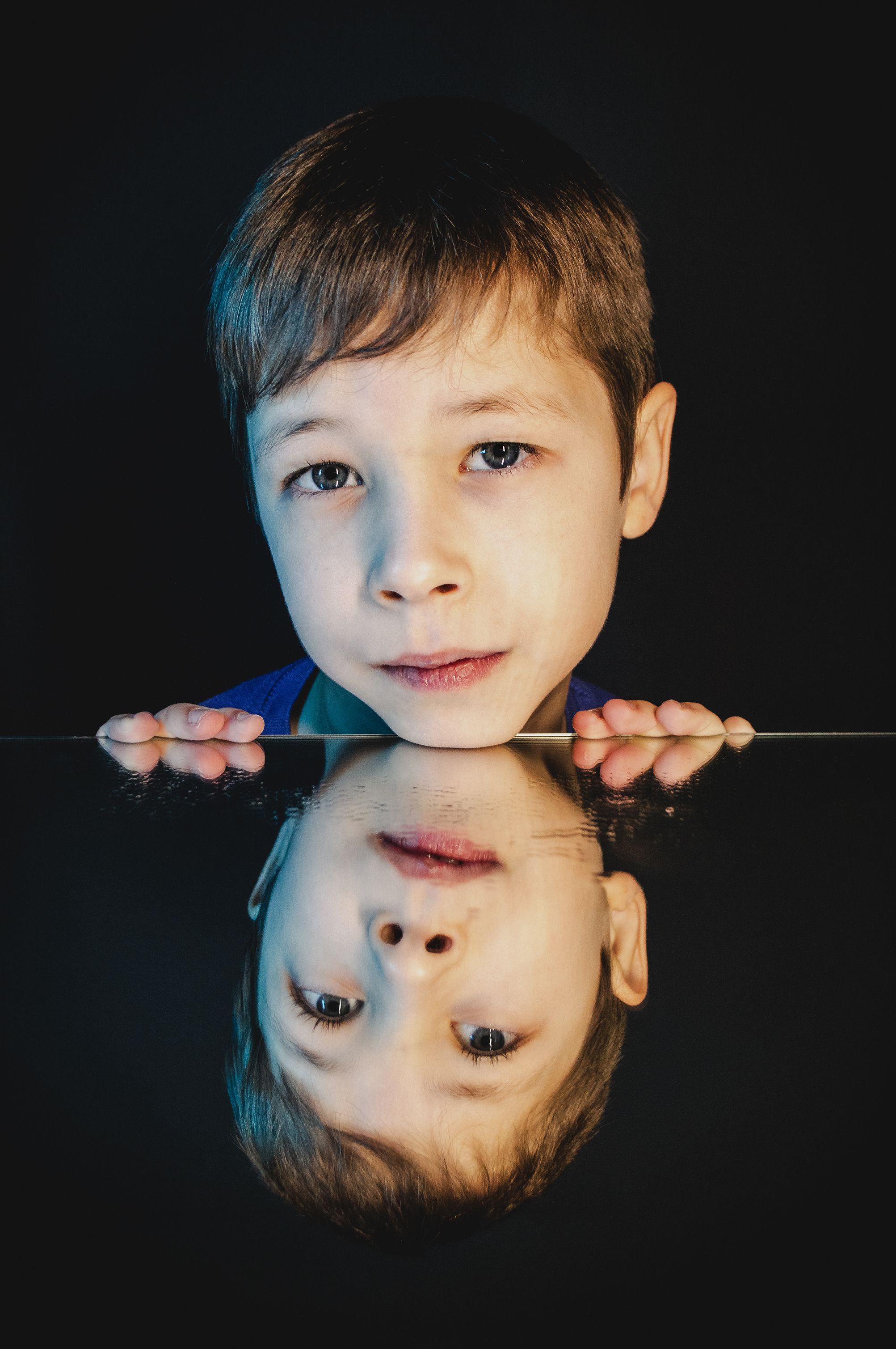 A Kid in Gray Sweater Reflection on Glass Surface · Free Stock Photo