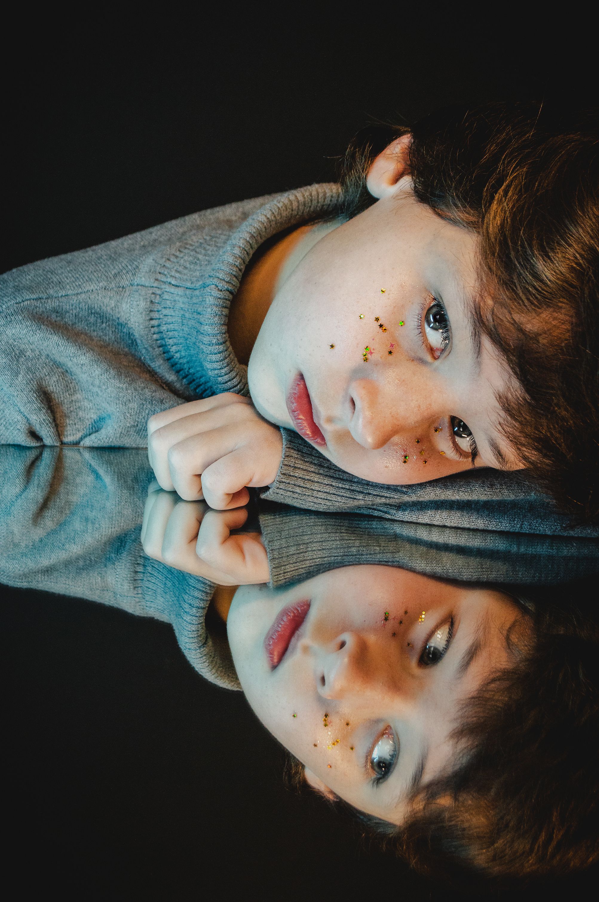 A Kid in Gray Sweater with Reflection on Glass Table · Free Stock Photo