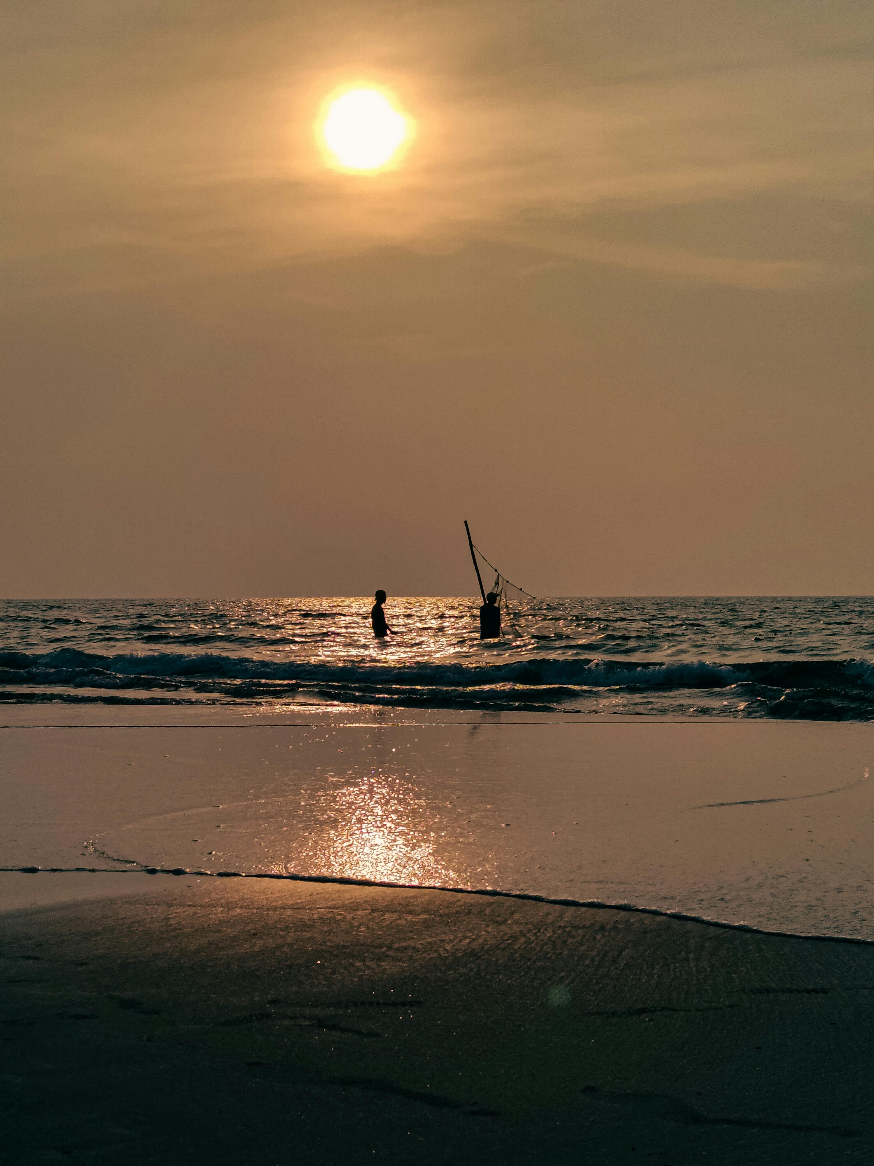 People Watching Sunset near Water · Free Stock Photo
