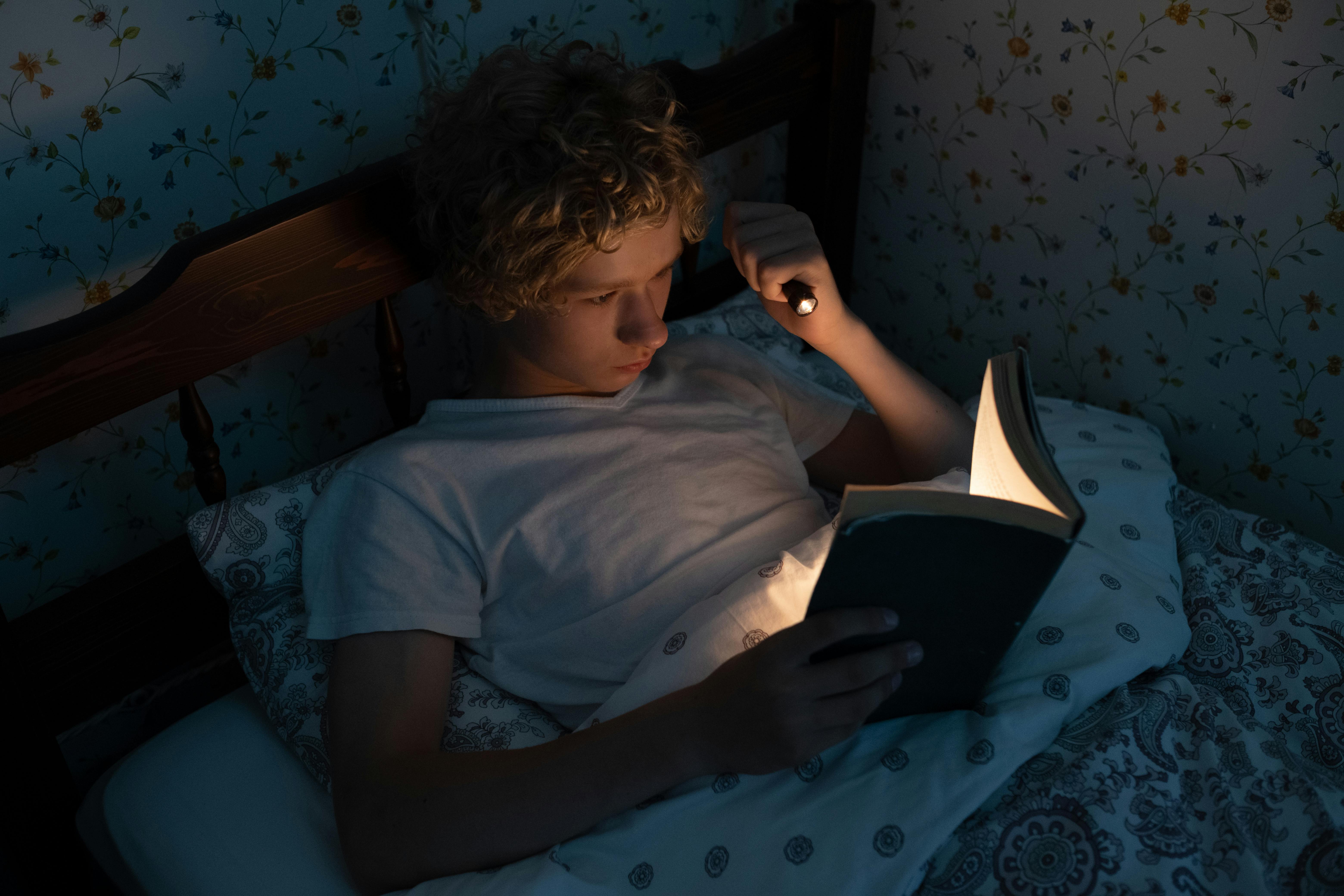 Teenager Reading in Bed at Night · Free Stock Photo