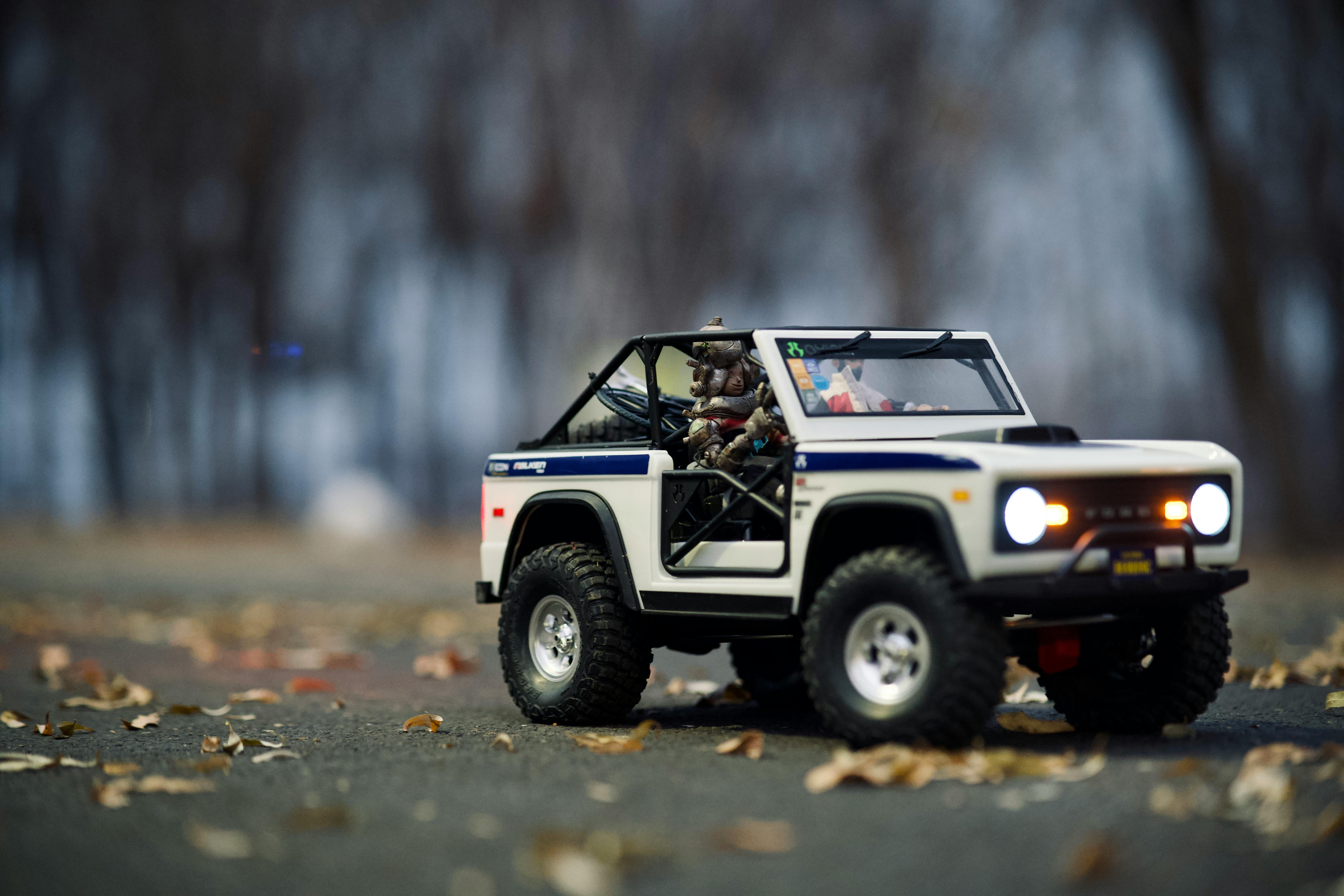 Tilt-shift Photography of Classic Car Scale Model Near Two Figurines ...