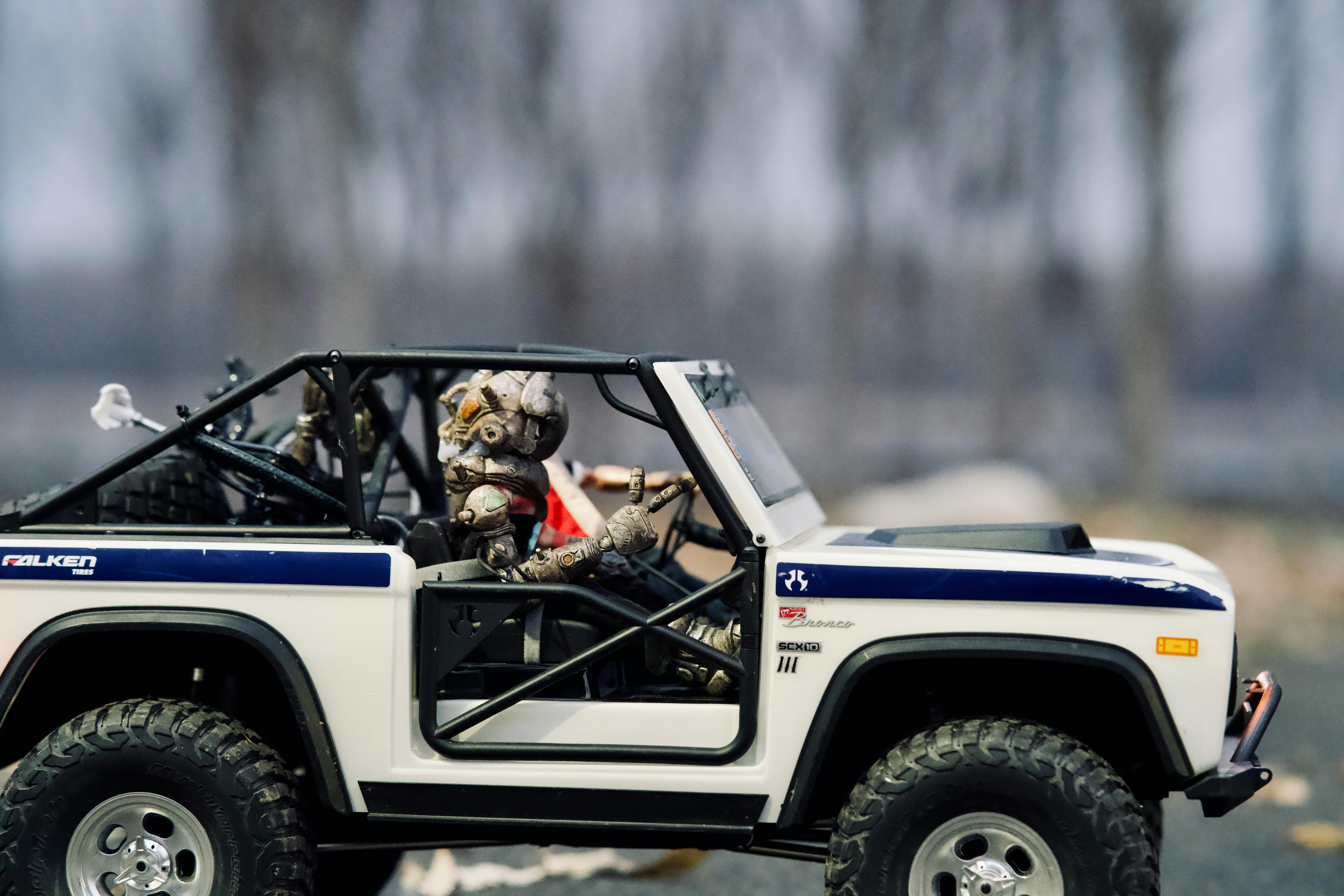 Green Scale Model Car on Brown Pavement · Free Stock Photo