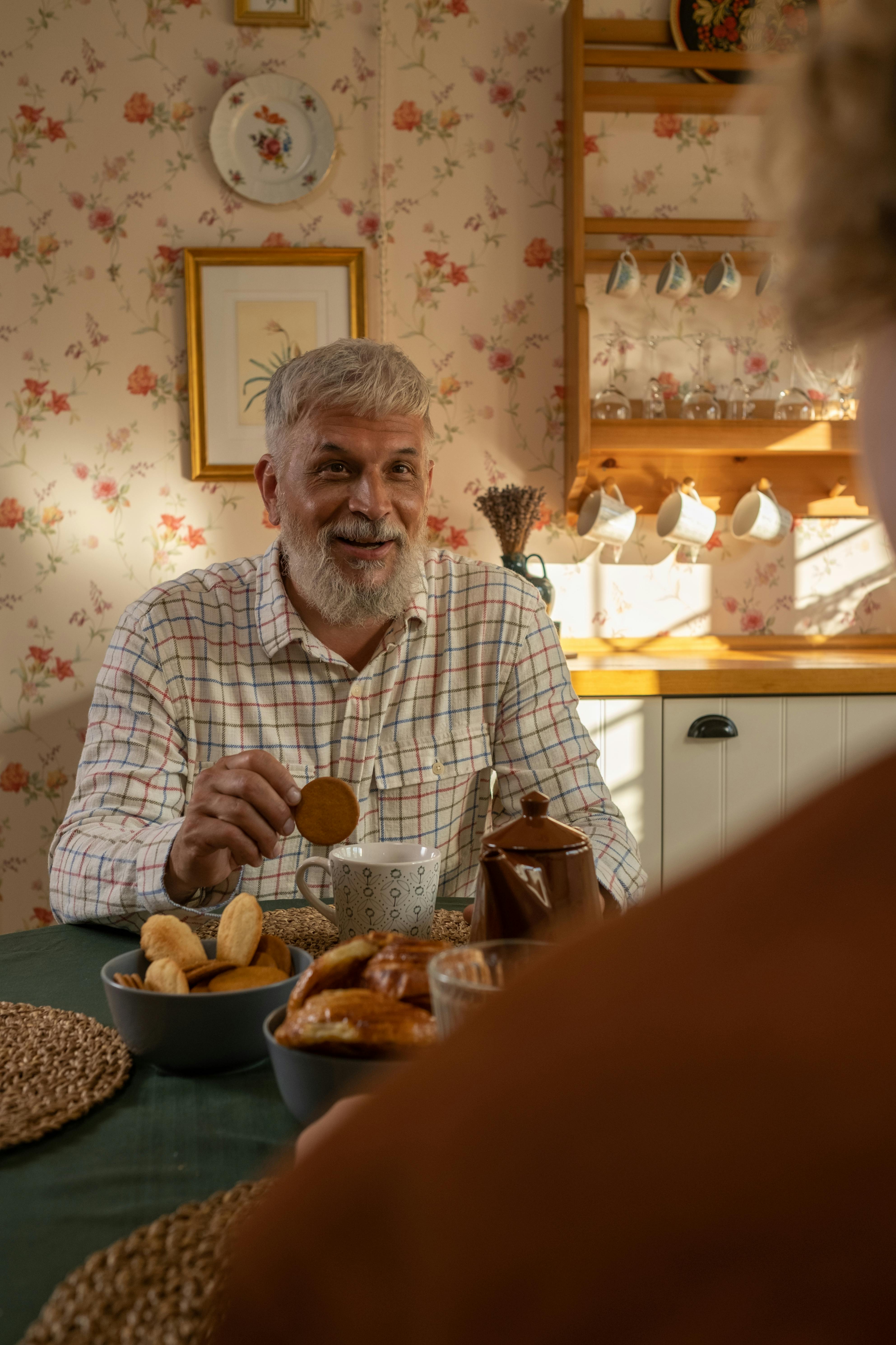 Elderly Man Smiling and Holding Cookie · Free Stock Photo