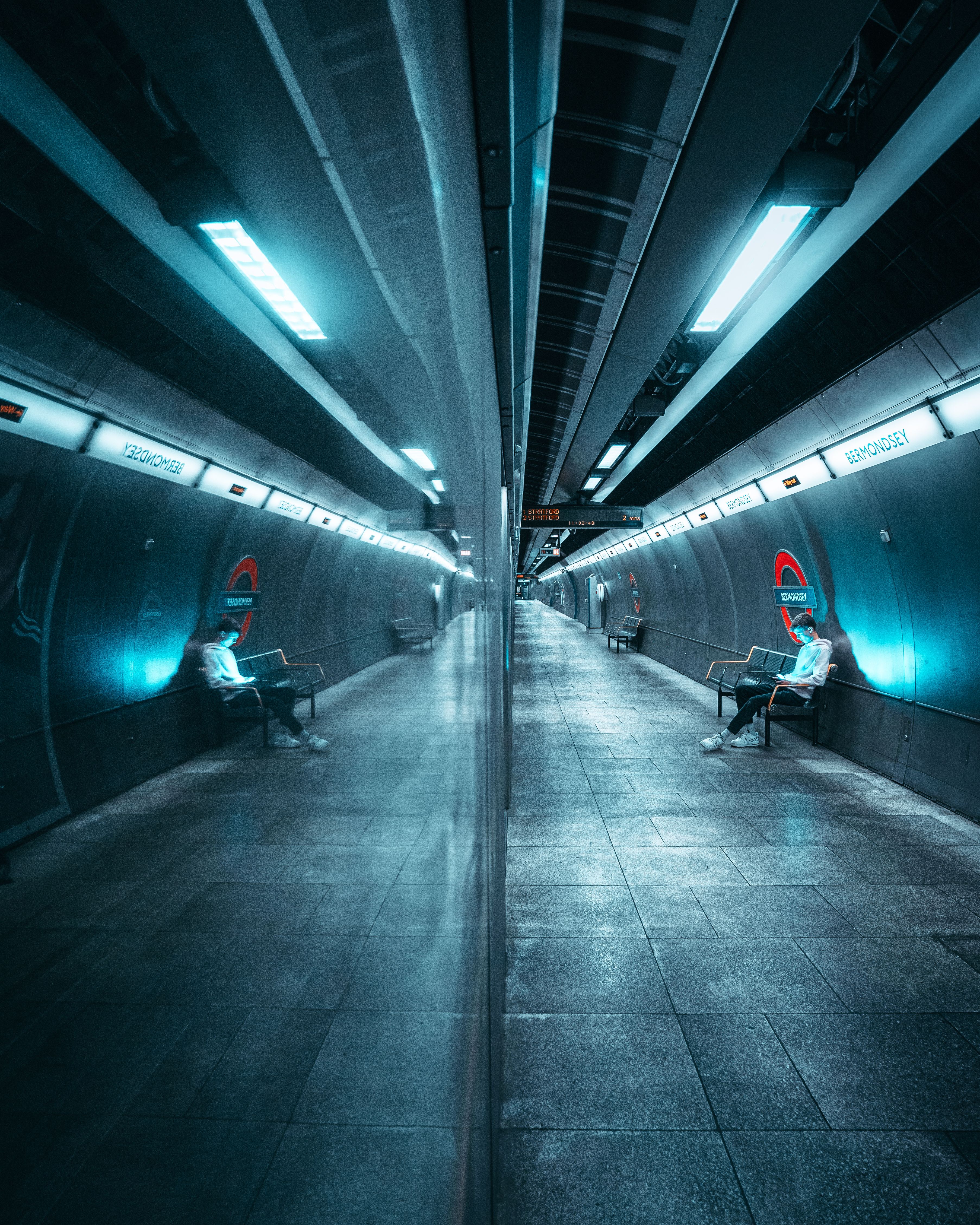 Man Sitting on a Bench in an Underground Station · Free Stock Photo