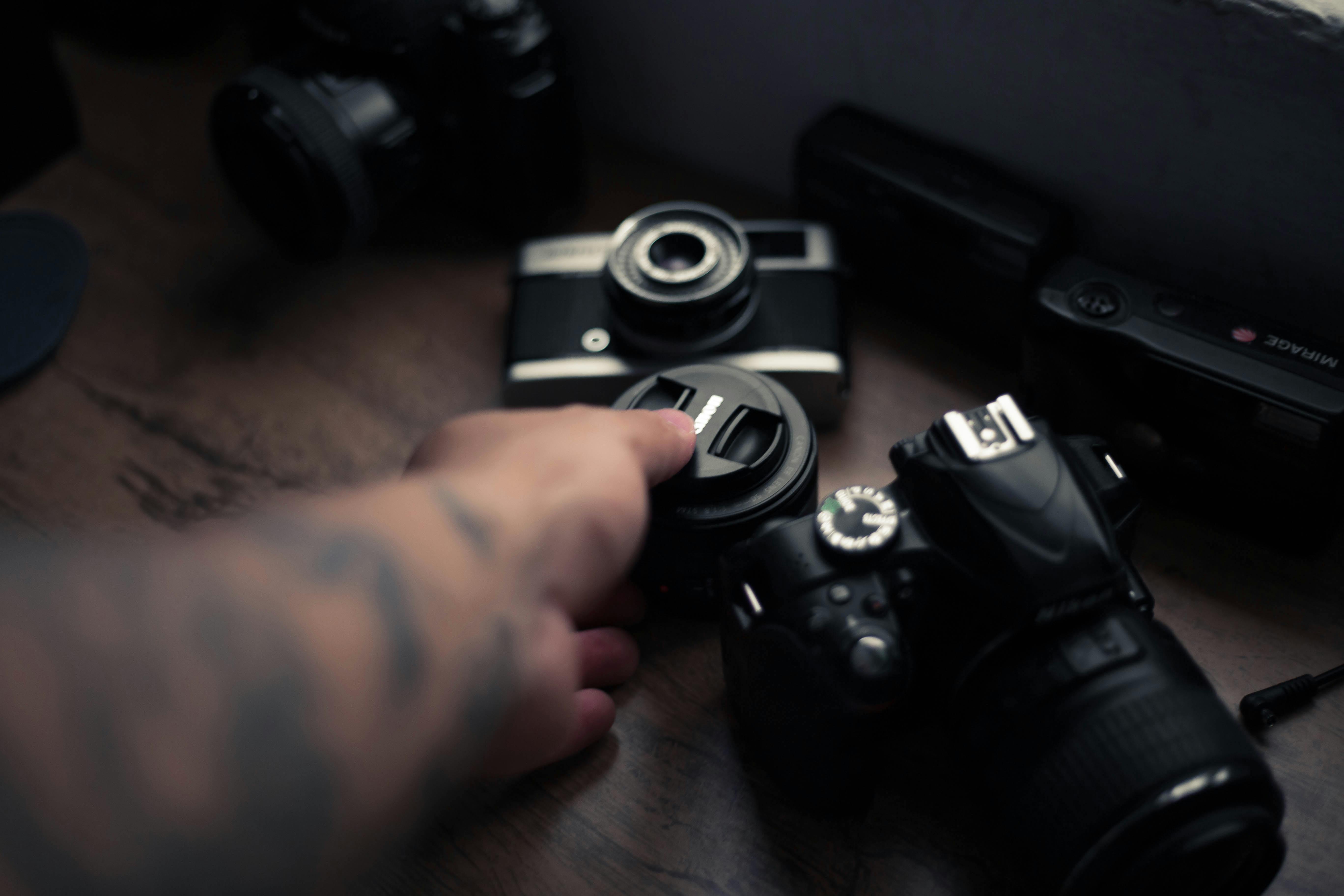 Person Holding Camera Lens · Free Stock Photo