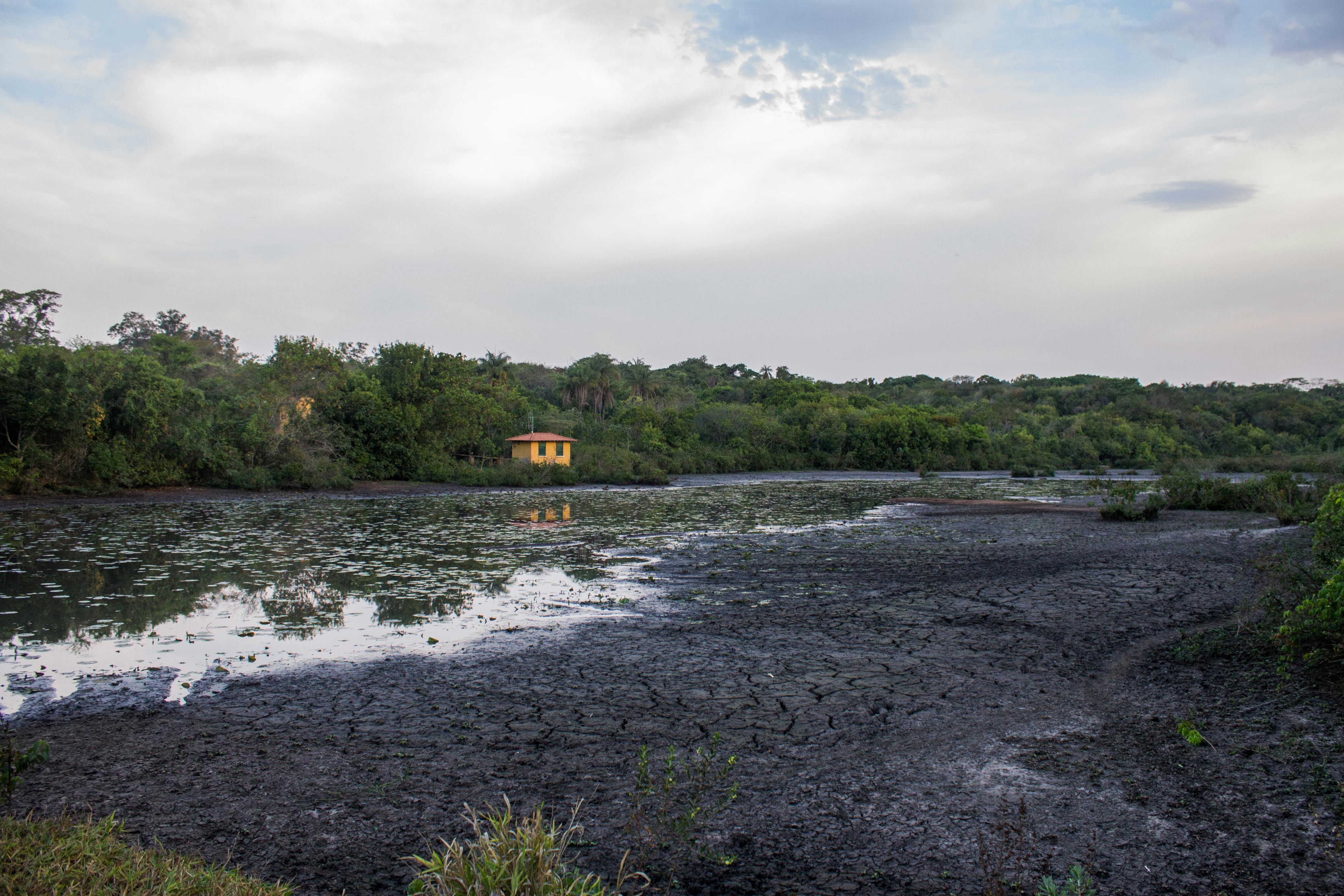 A Yellow House Beside River Under Cloudy Sky · Free Stock Photo