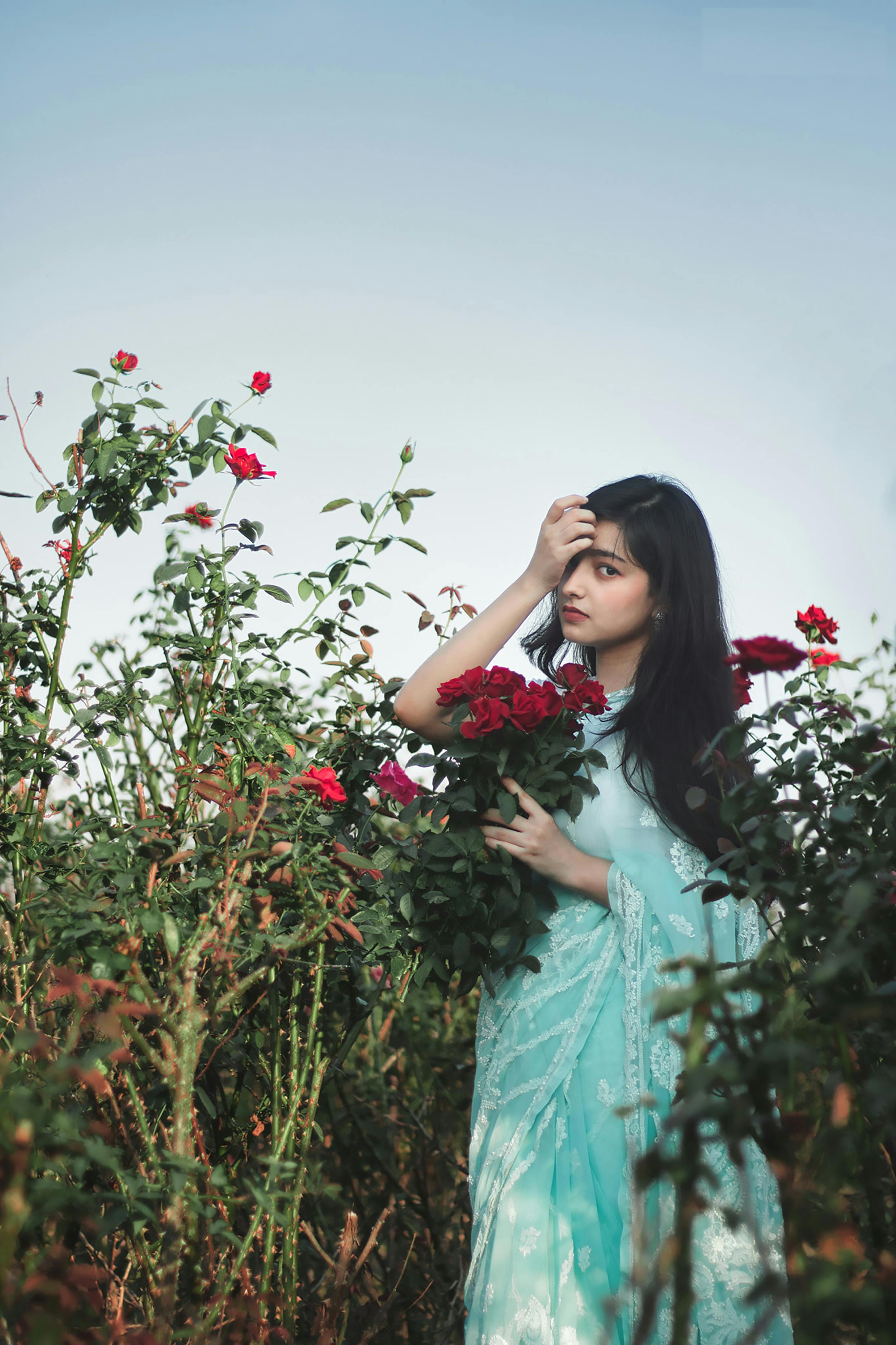 A Woman Posing in the Red Roses Field · Free Stock Photo