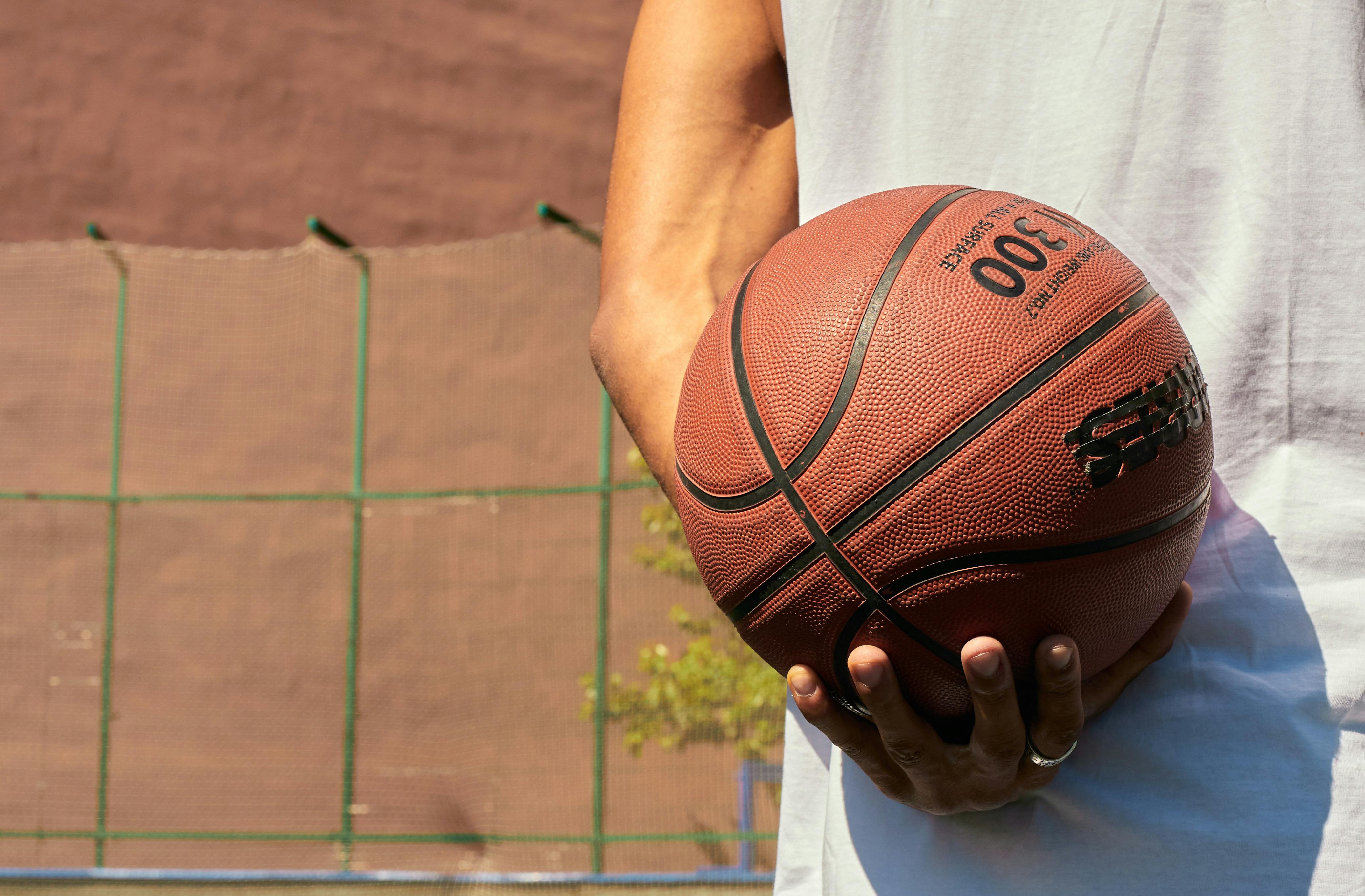 Photo of a Man Holding a Ball · Free Stock Photo