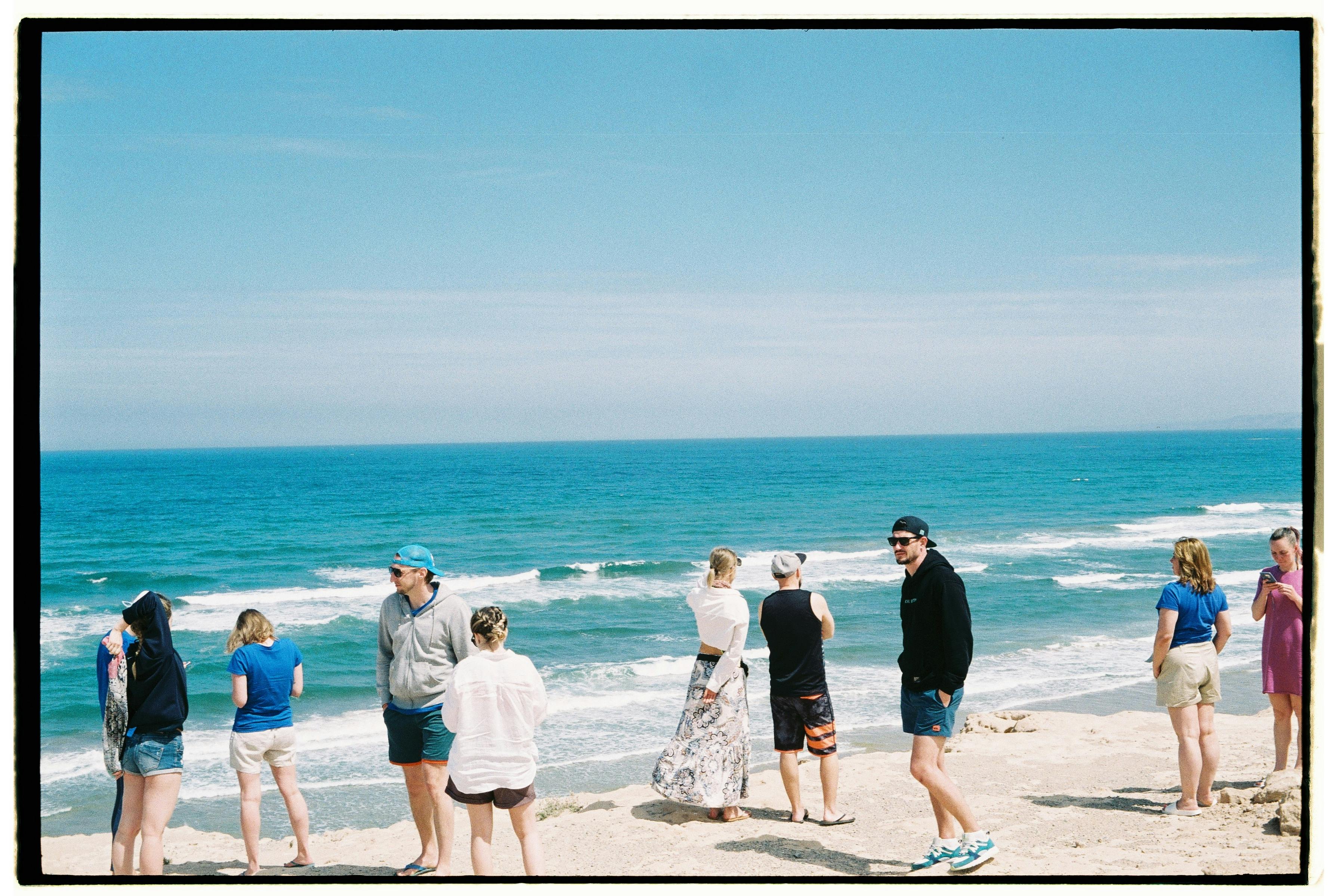 Busy People Standing on the Beautiful Beach · Free Stock Photo
