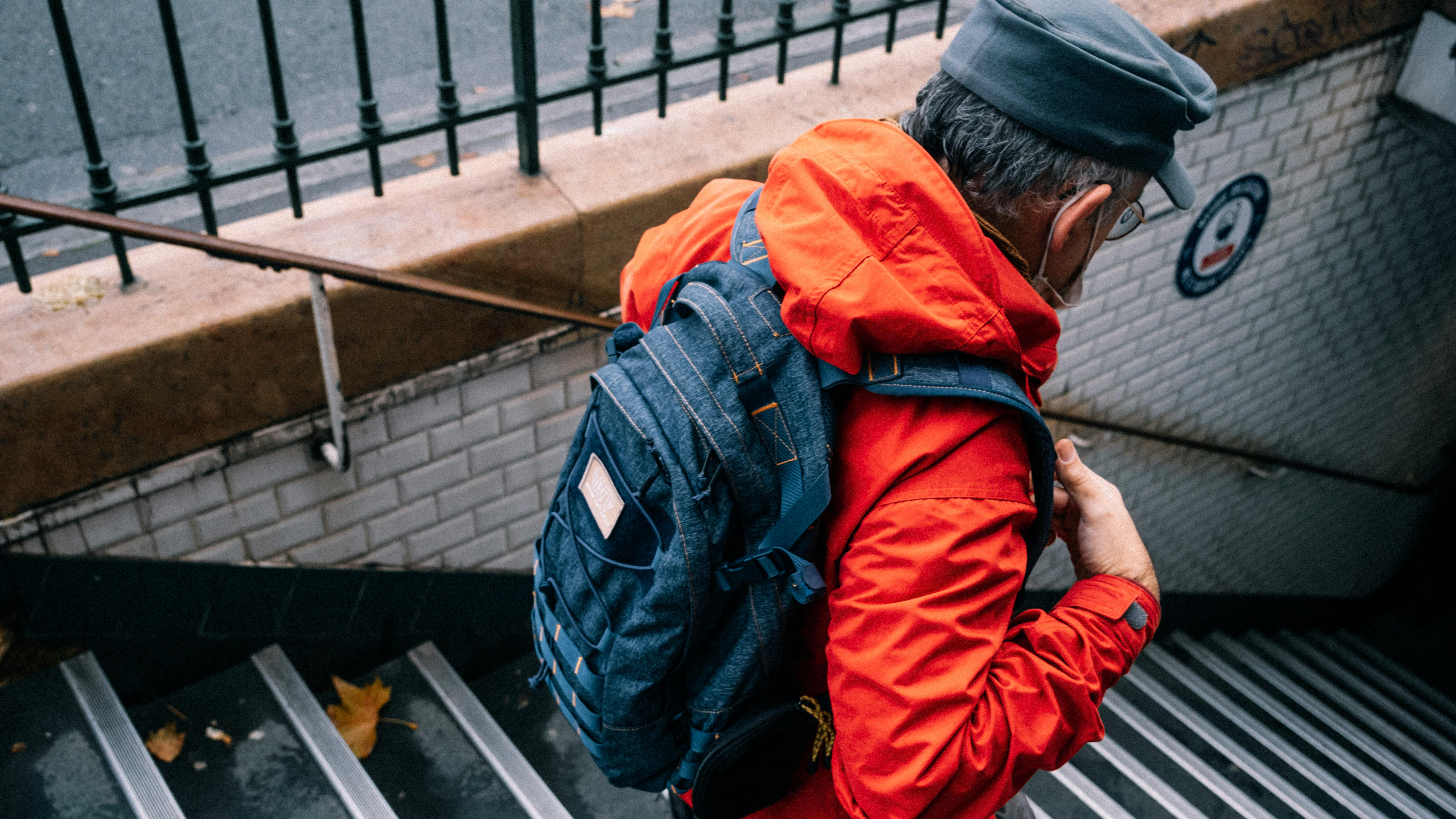 Man Carrying Backpack While Going Down · Free Stock Photo