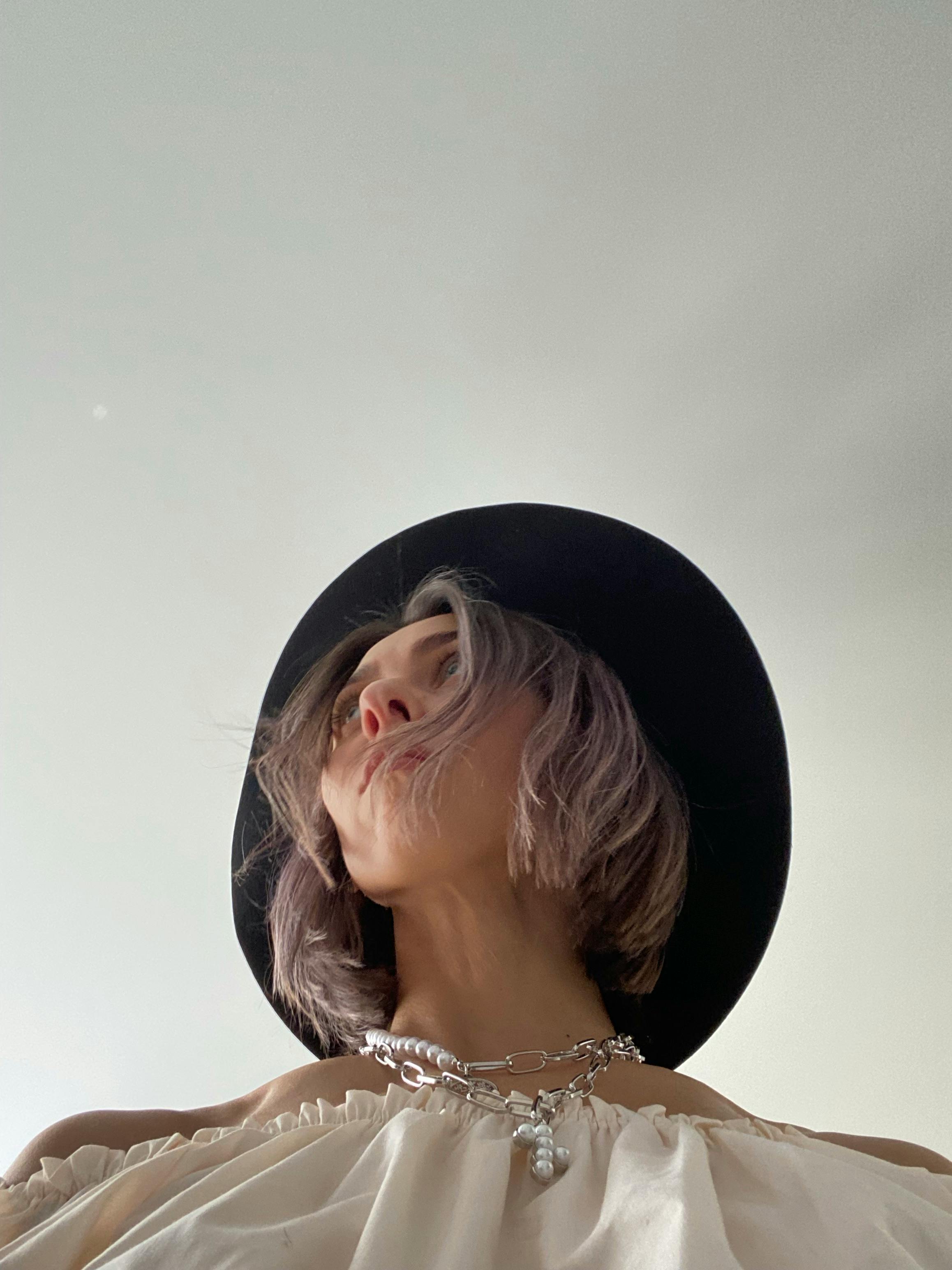 Low Angle Shot of a Woman Wearing a Hat · Free Stock Photo