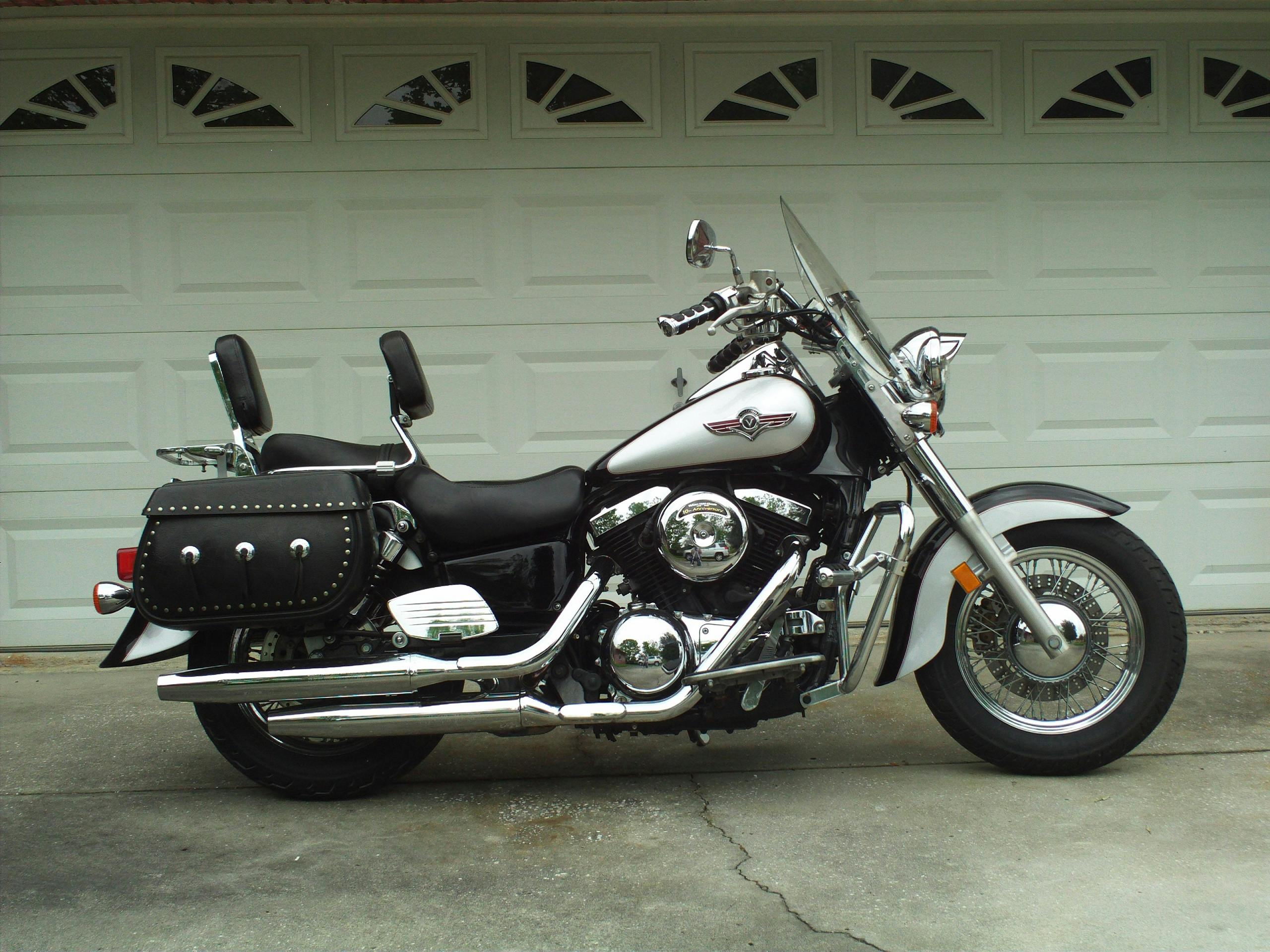 Classic Chrome Motorbike near Garage · Free Stock Photo