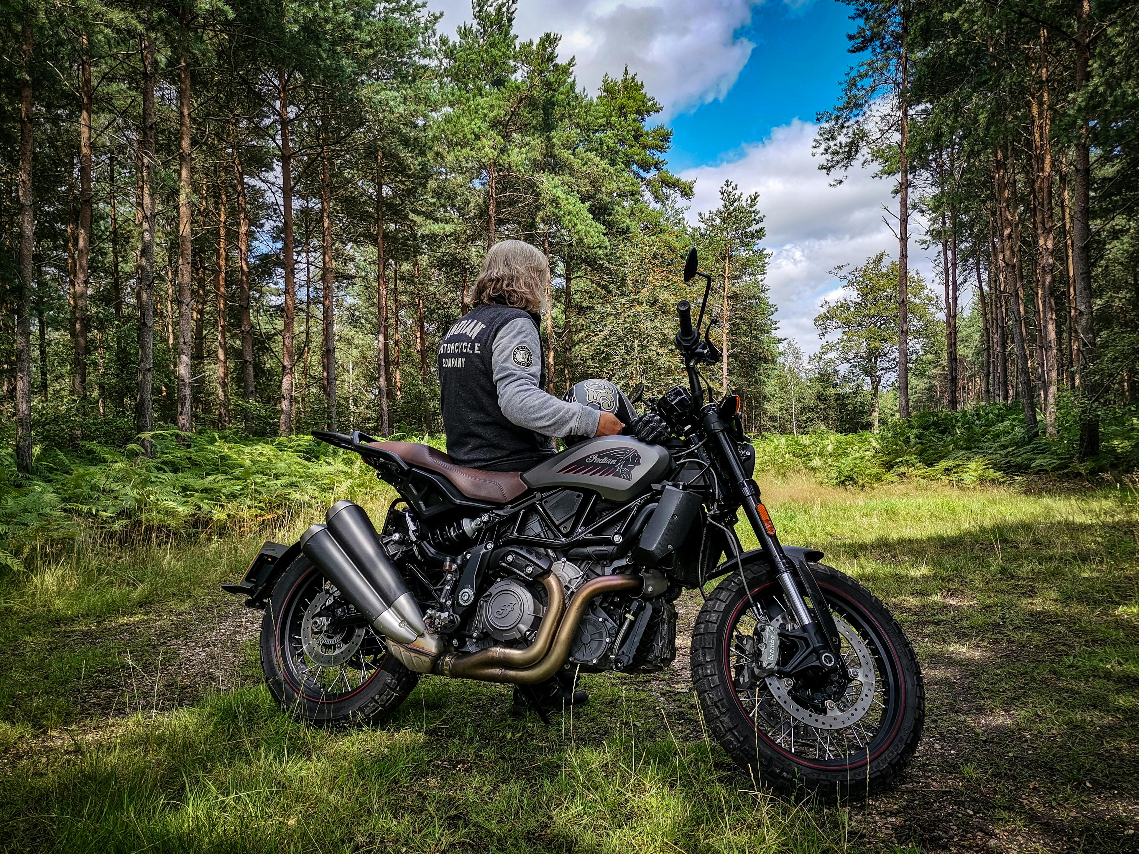 A Person with a Motorcycle in a Forest · Free Stock Photo