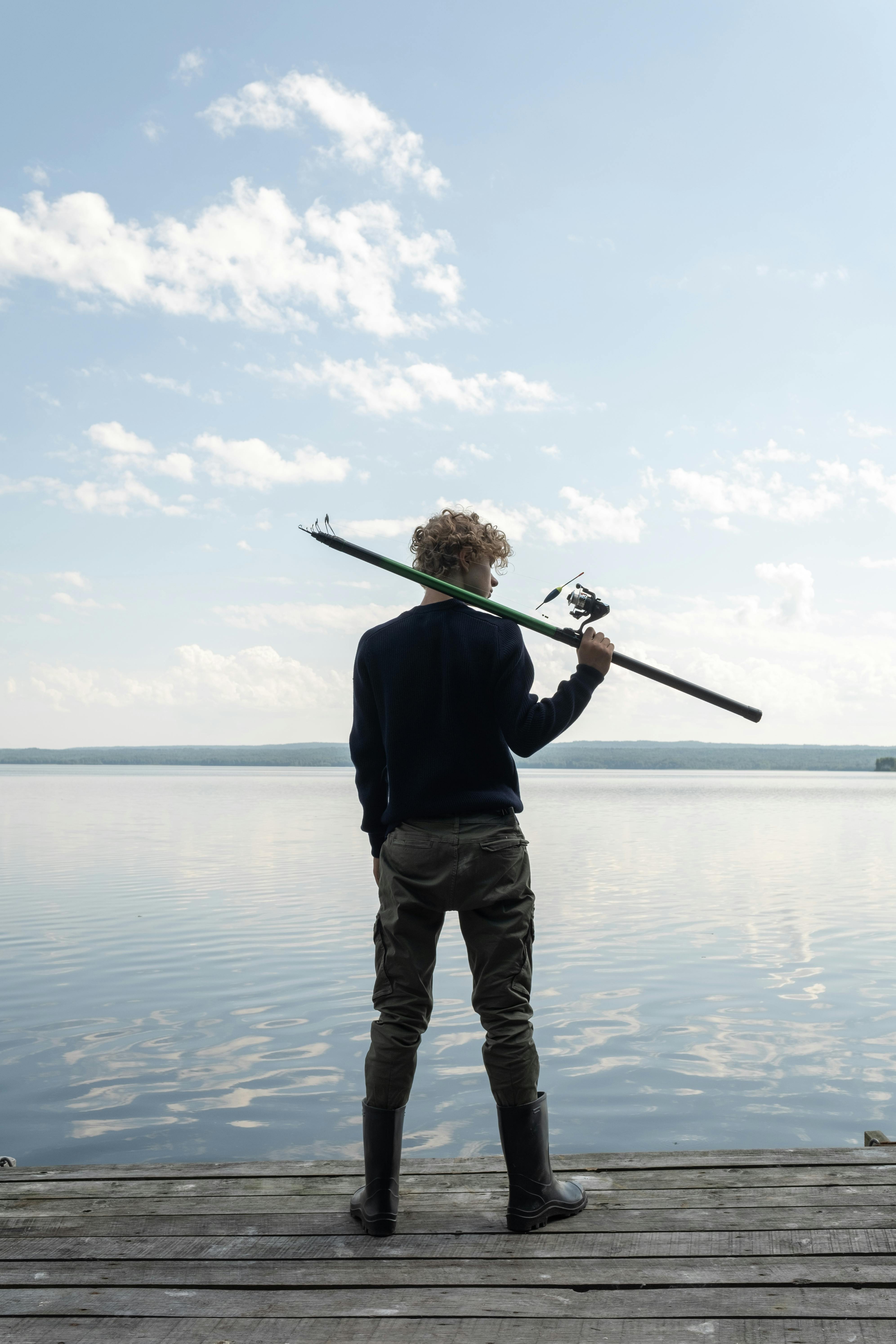 Boy Standing on Pier with Fishing Rod · Free Stock Photo
