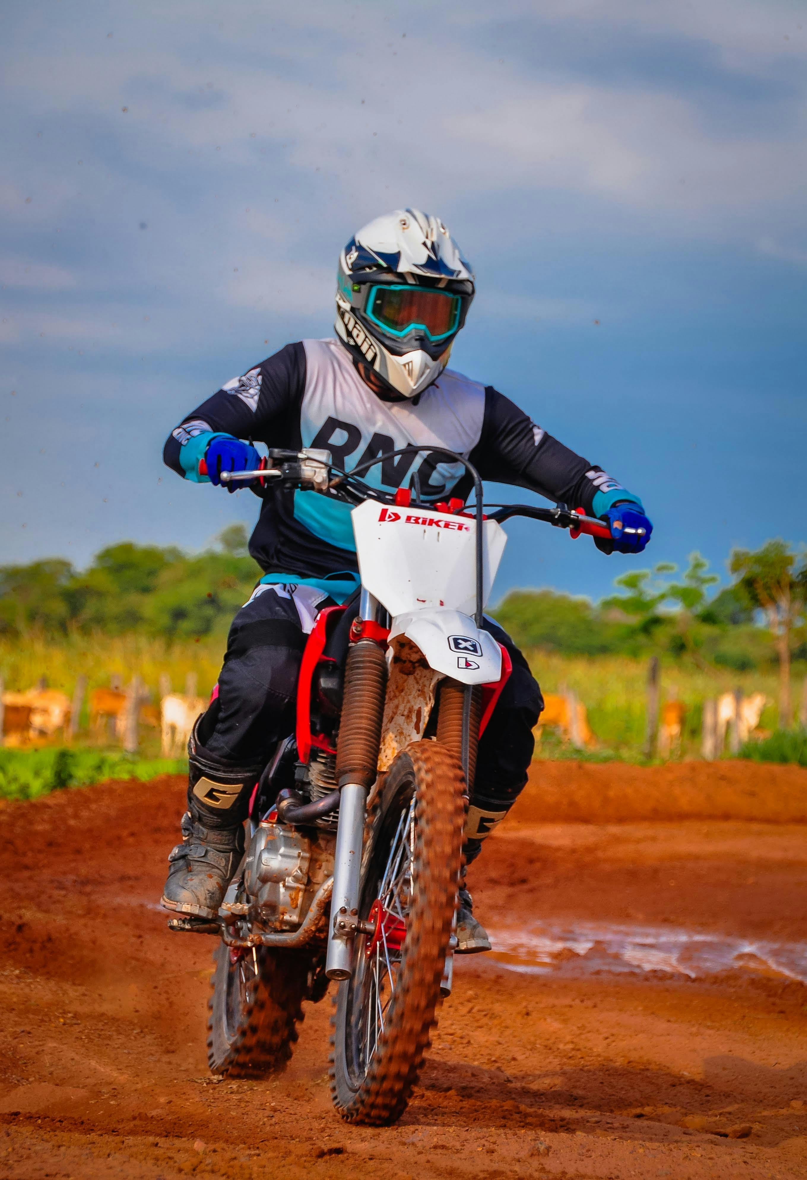 Man in White and Black Motocross Helmet Riding Motocross Dirt Bike ...