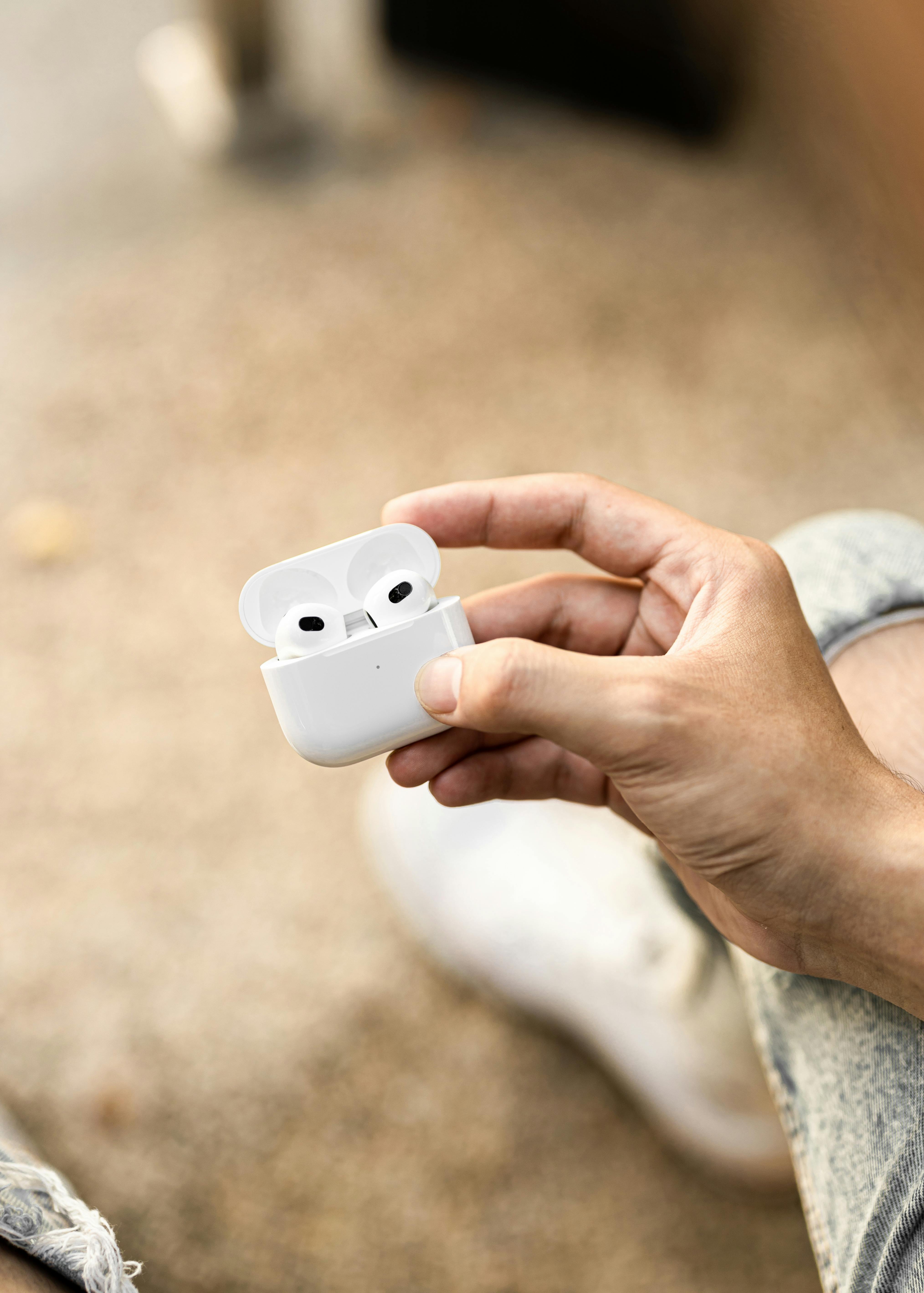 Close-Up Photo of Person Holding Apple Airpods · Free Stock Photo