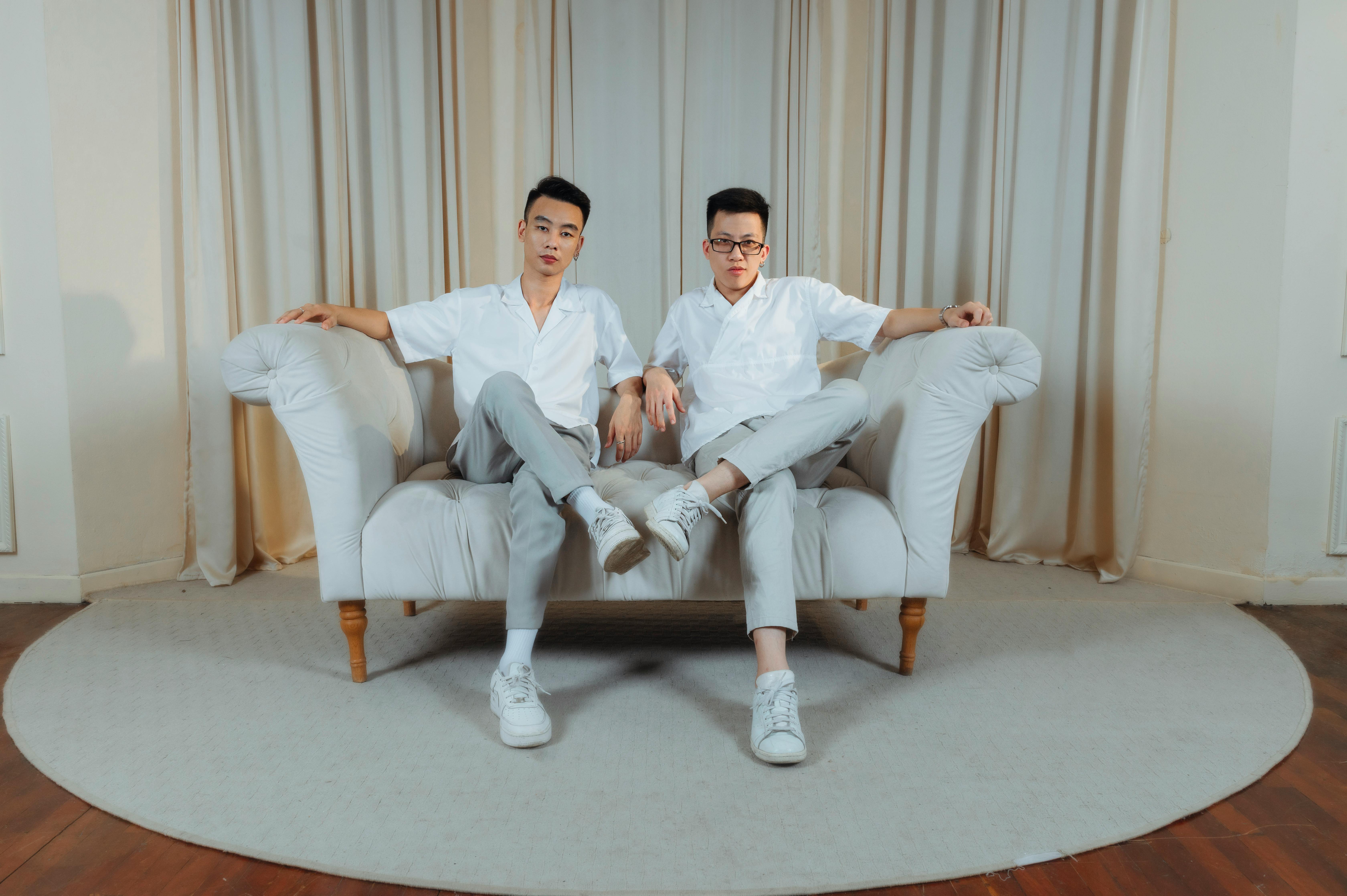 Man Wearing Suit Jacket Sitting on Yellow Sofa · Free Stock Photo