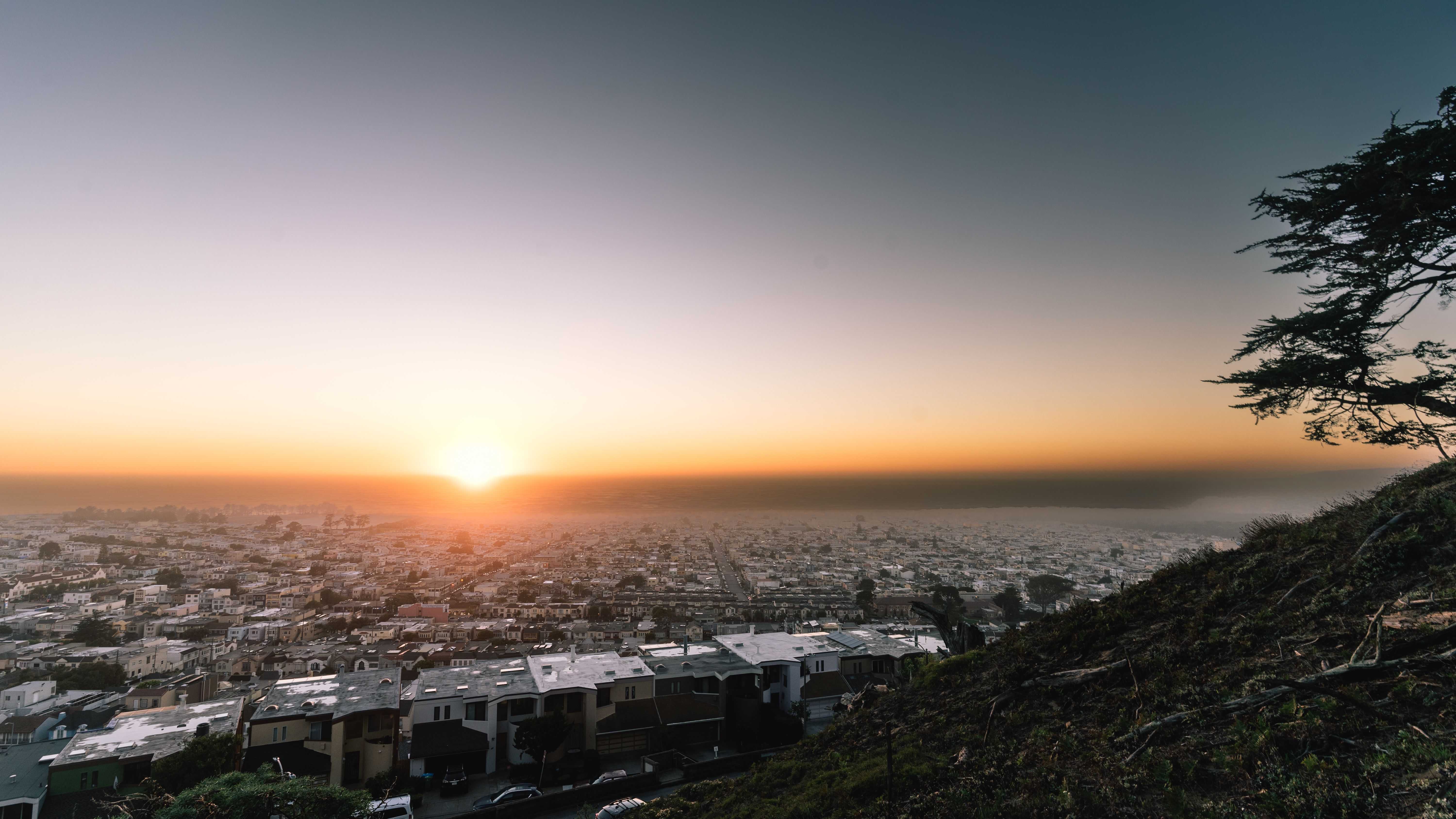 Aerial View of Cityscape with Sunset over the Horizon · Free Stock Photo