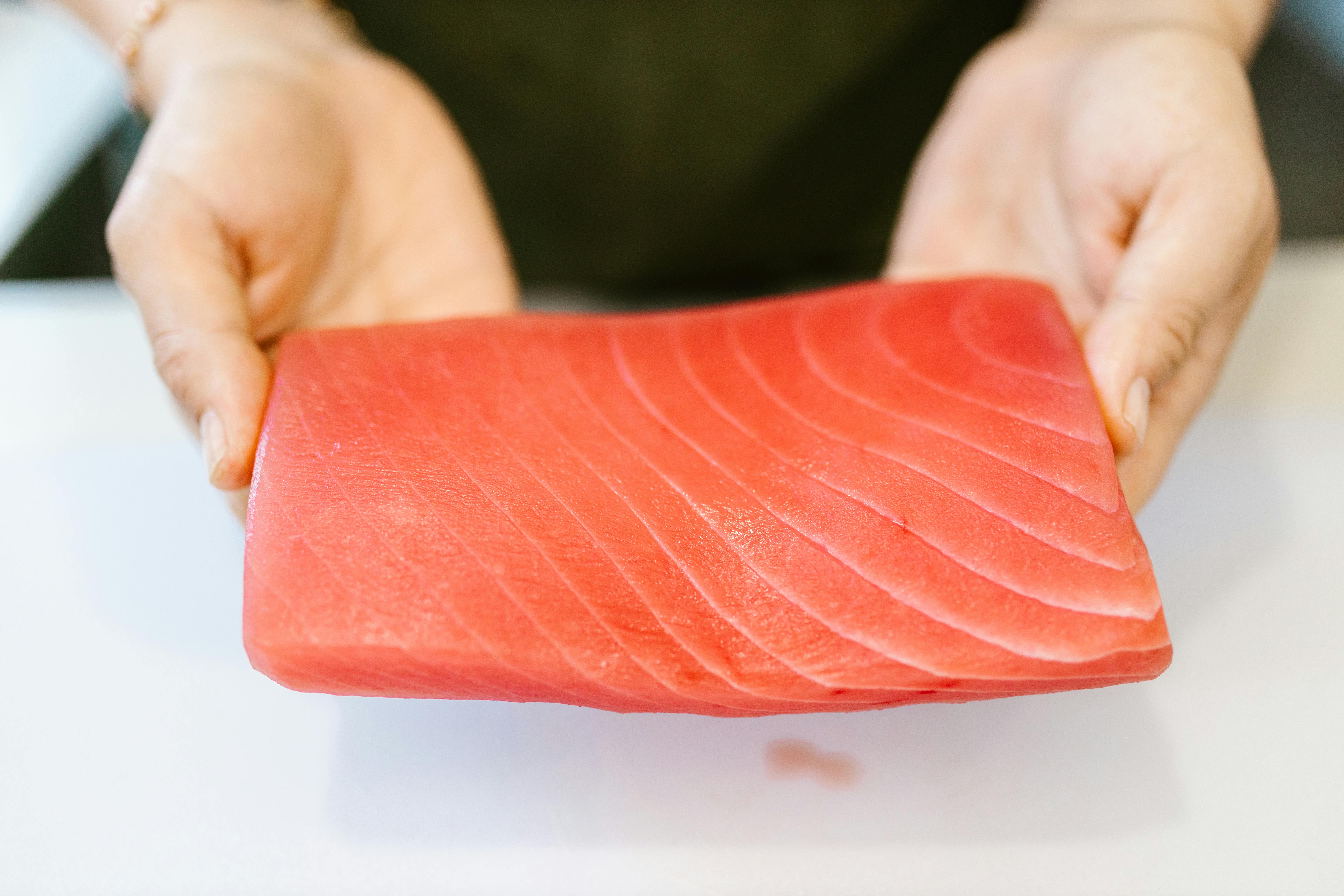Person Holding Raw Fish · Free Stock Photo