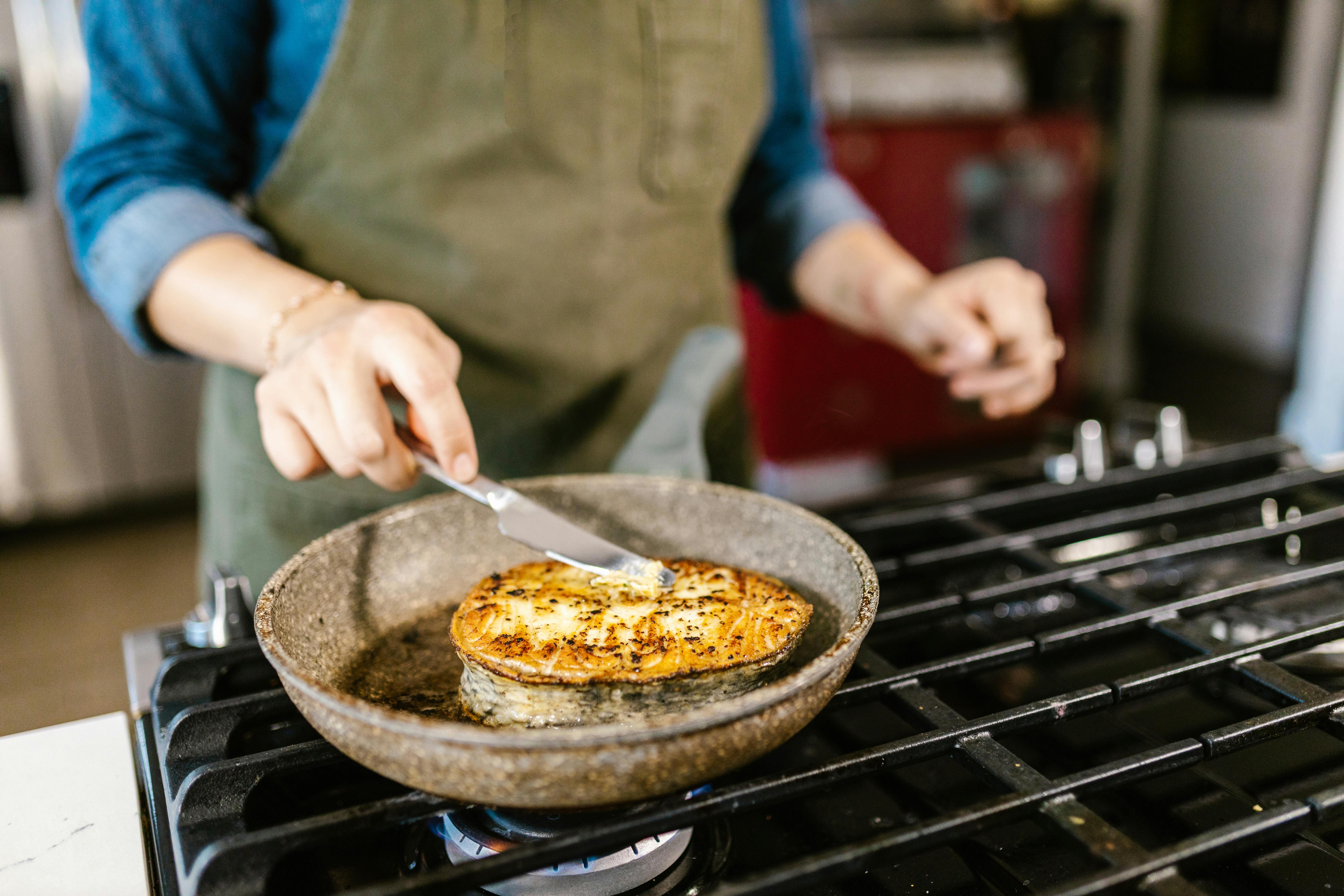 Person Holding a Frying Pan With Pancake · Free Stock Photo
