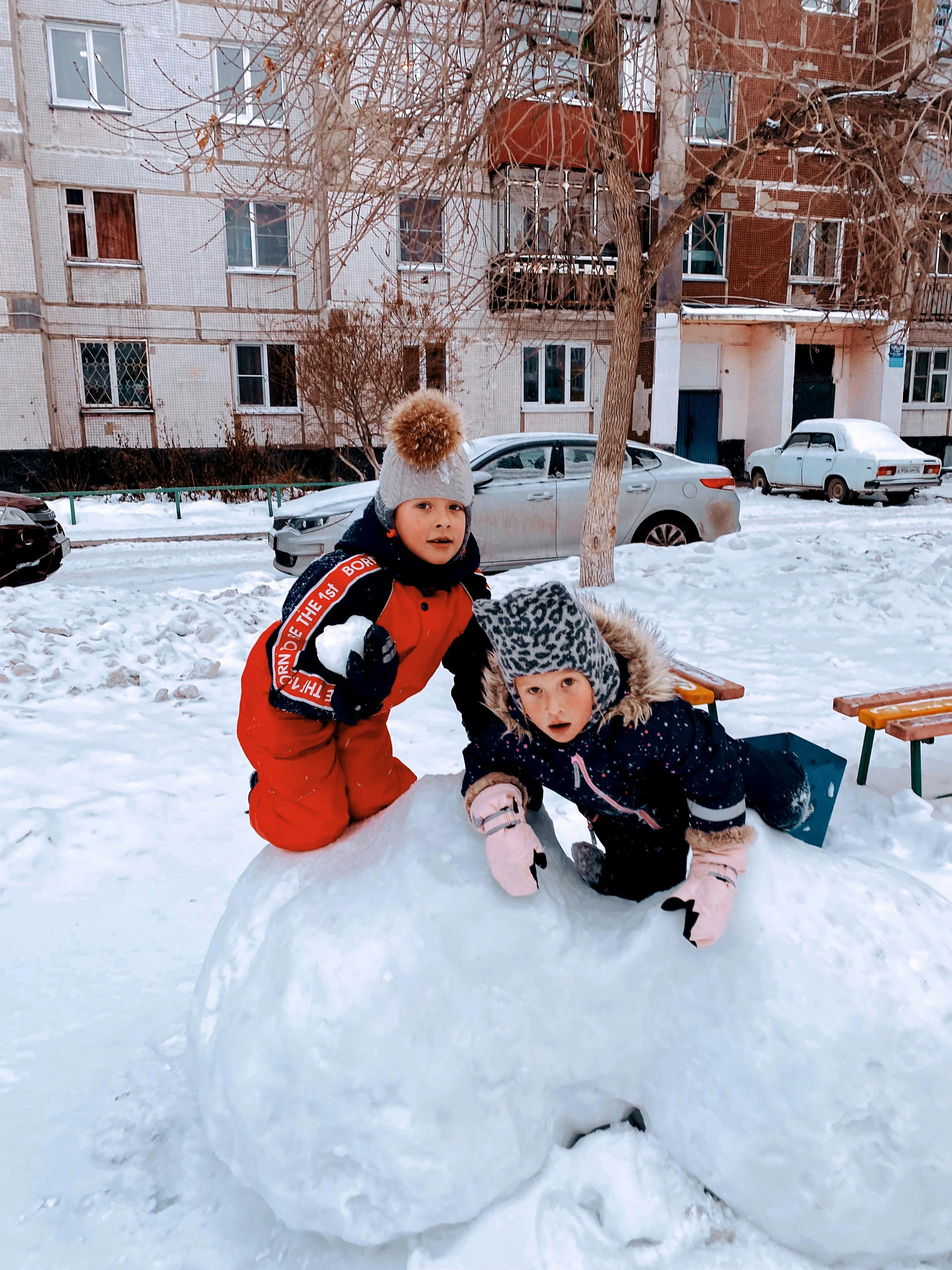 Children Playing on a Pile of Snow · Free Stock Photo