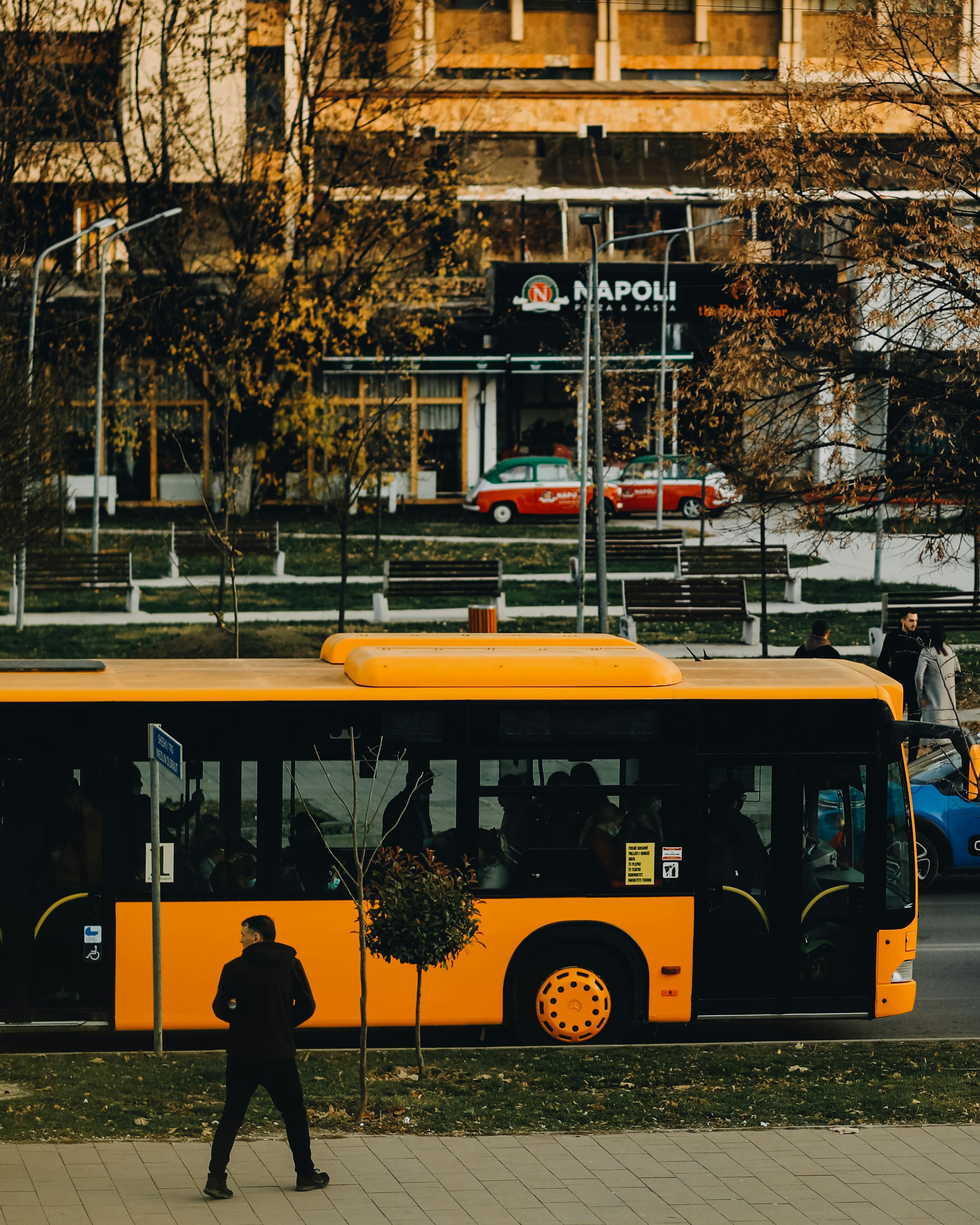 A Man Walking Towards a Bus · Free Stock Photo