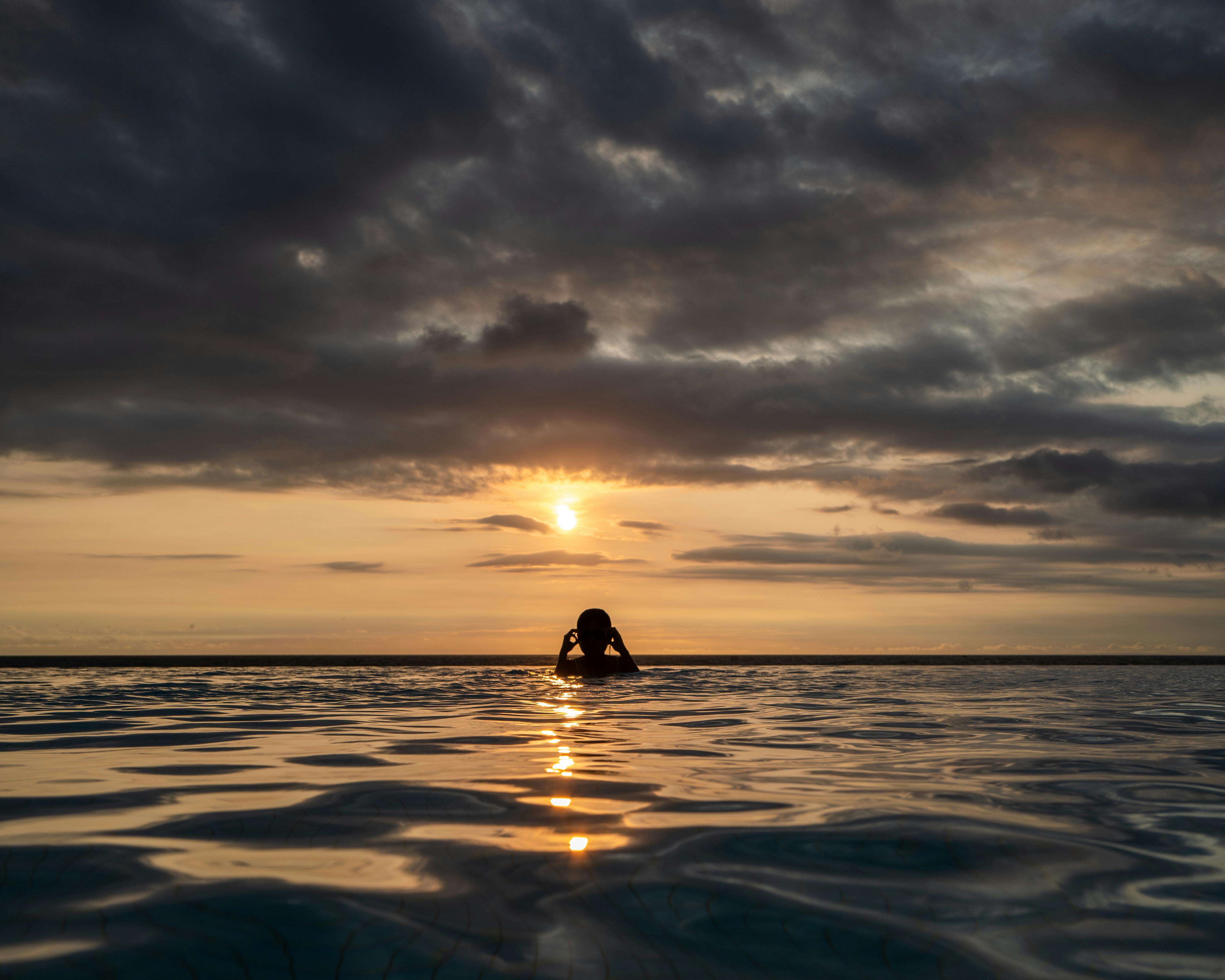 Silhouette of Woman Looking Out Window · Free Stock Photo