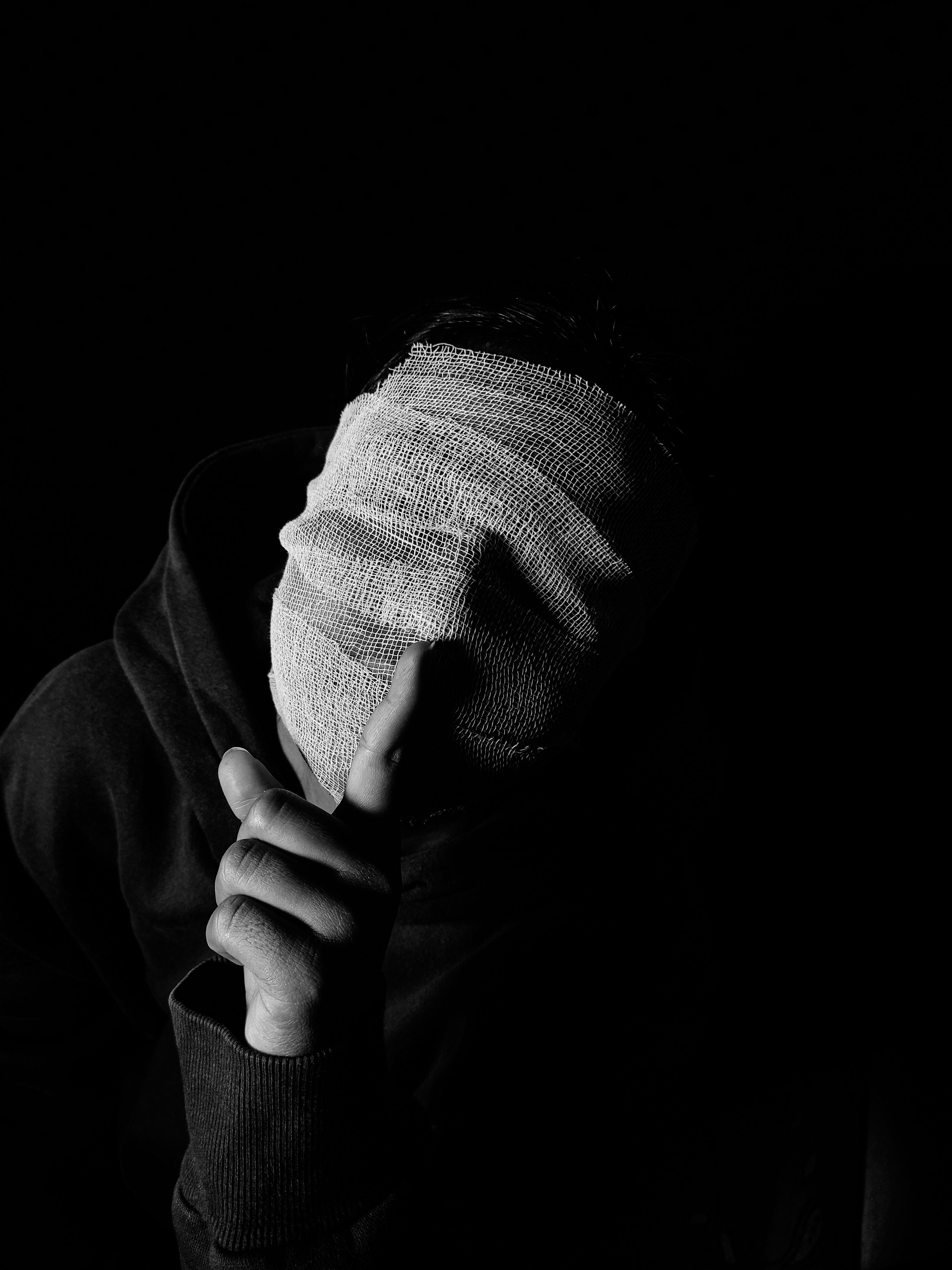 A Grayscale of a Man Wrapped with Bandage Making a Quiet Gesture · Free ...