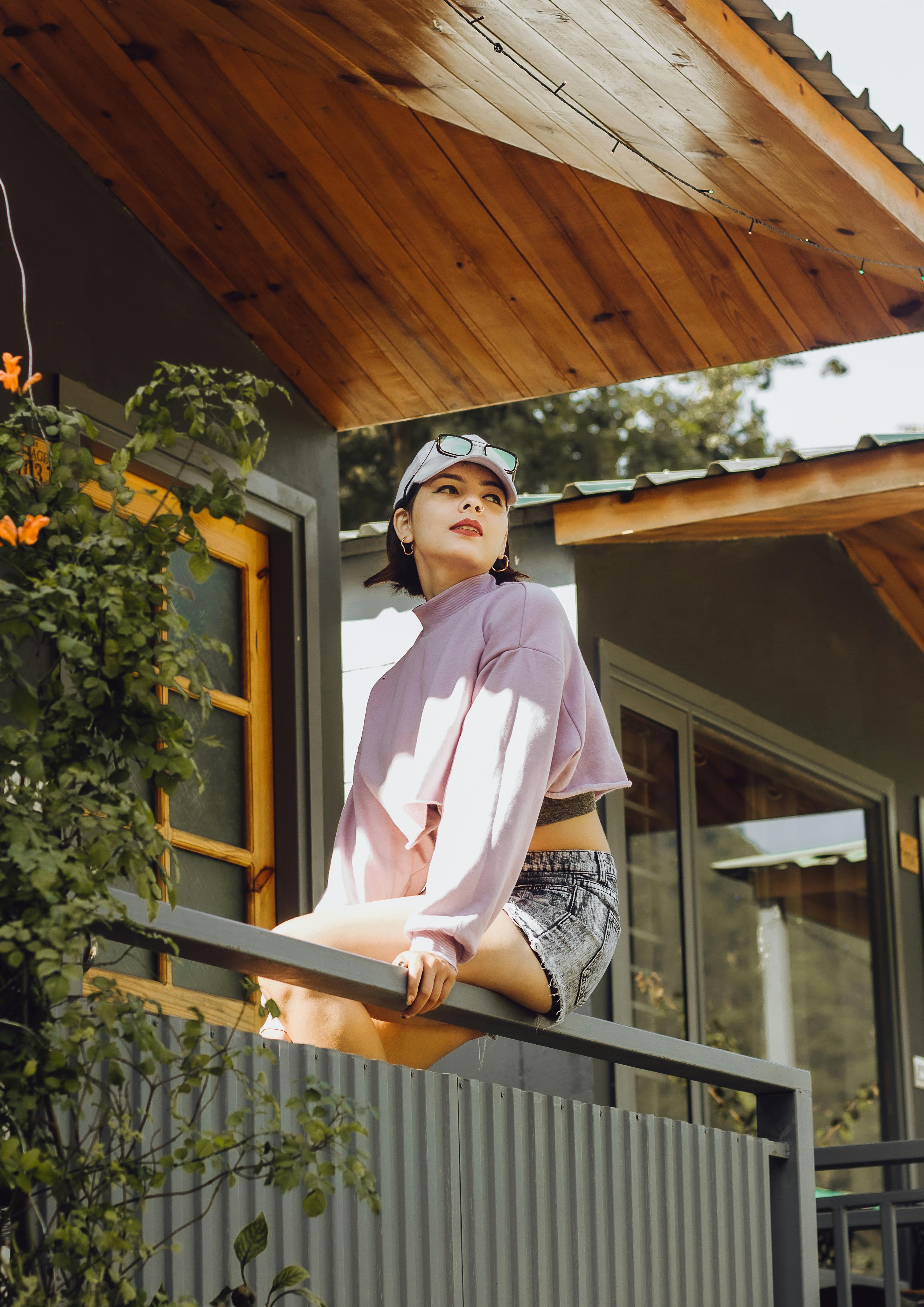Woman Sitting on Railing · Free Stock Photo