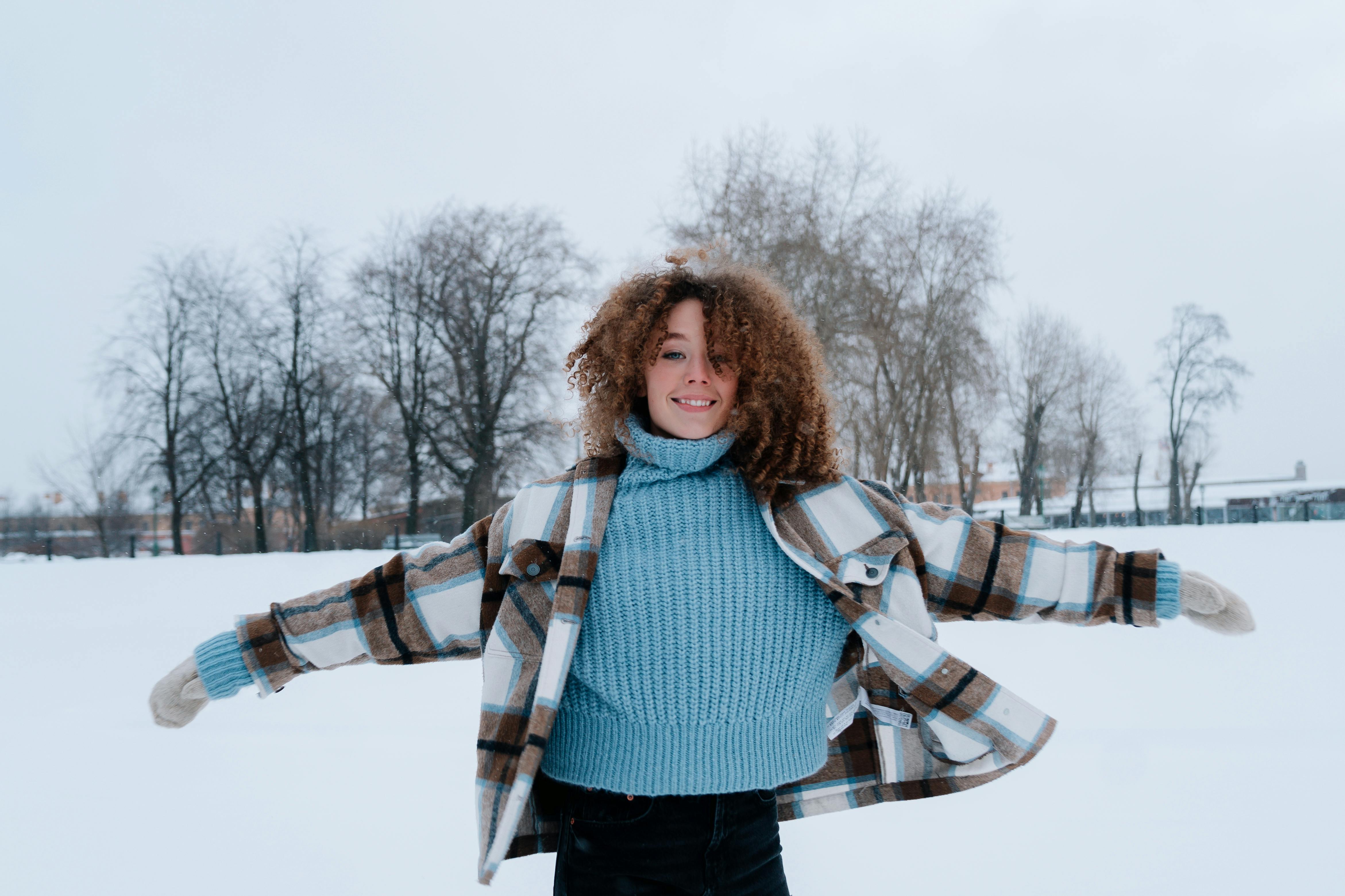 Woman with Curly Hair Wearing Winter Clothes Playing in Snow Field ...