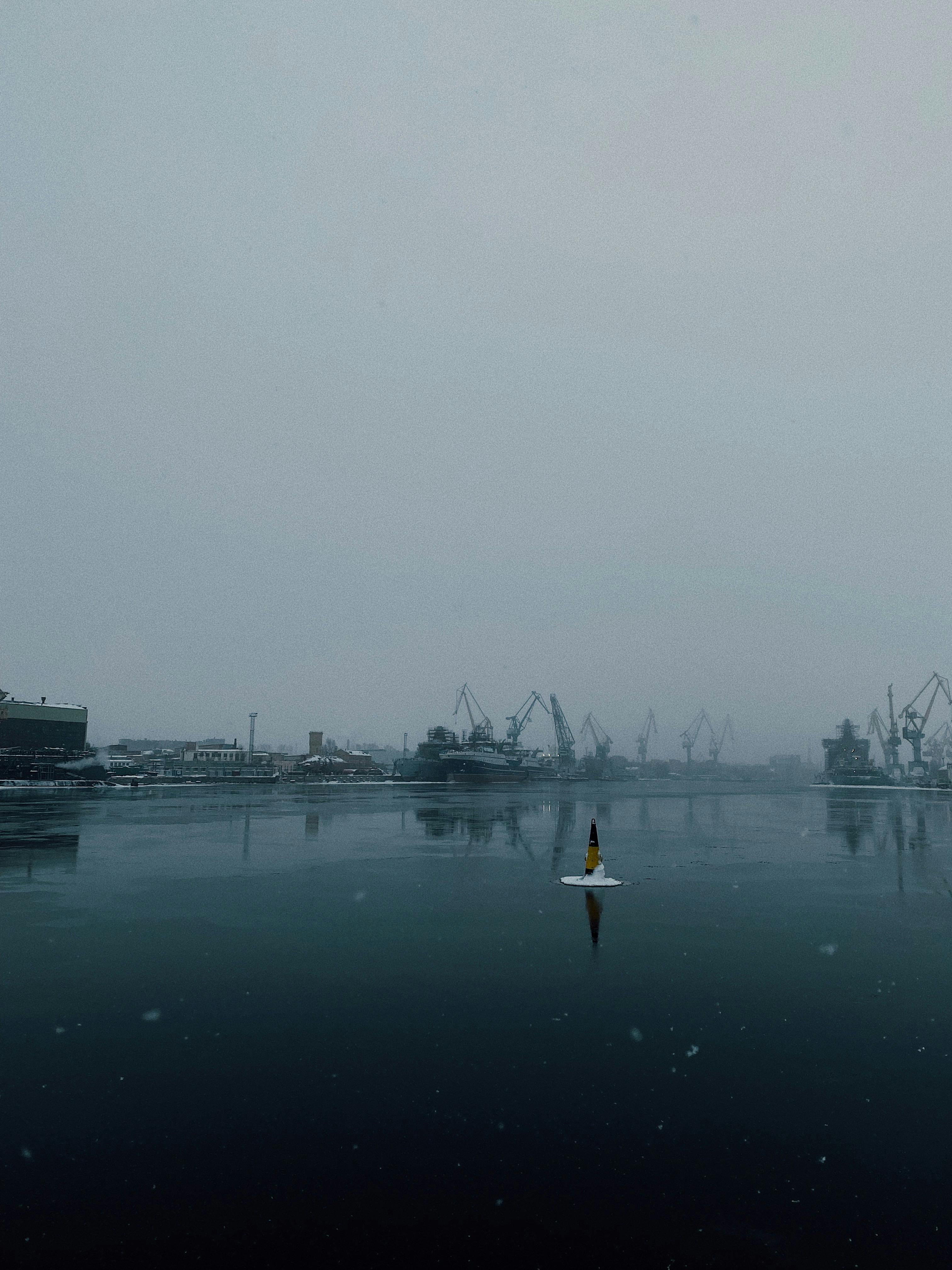 Snowfall on Sea with View of Shipyard · Free Stock Photo