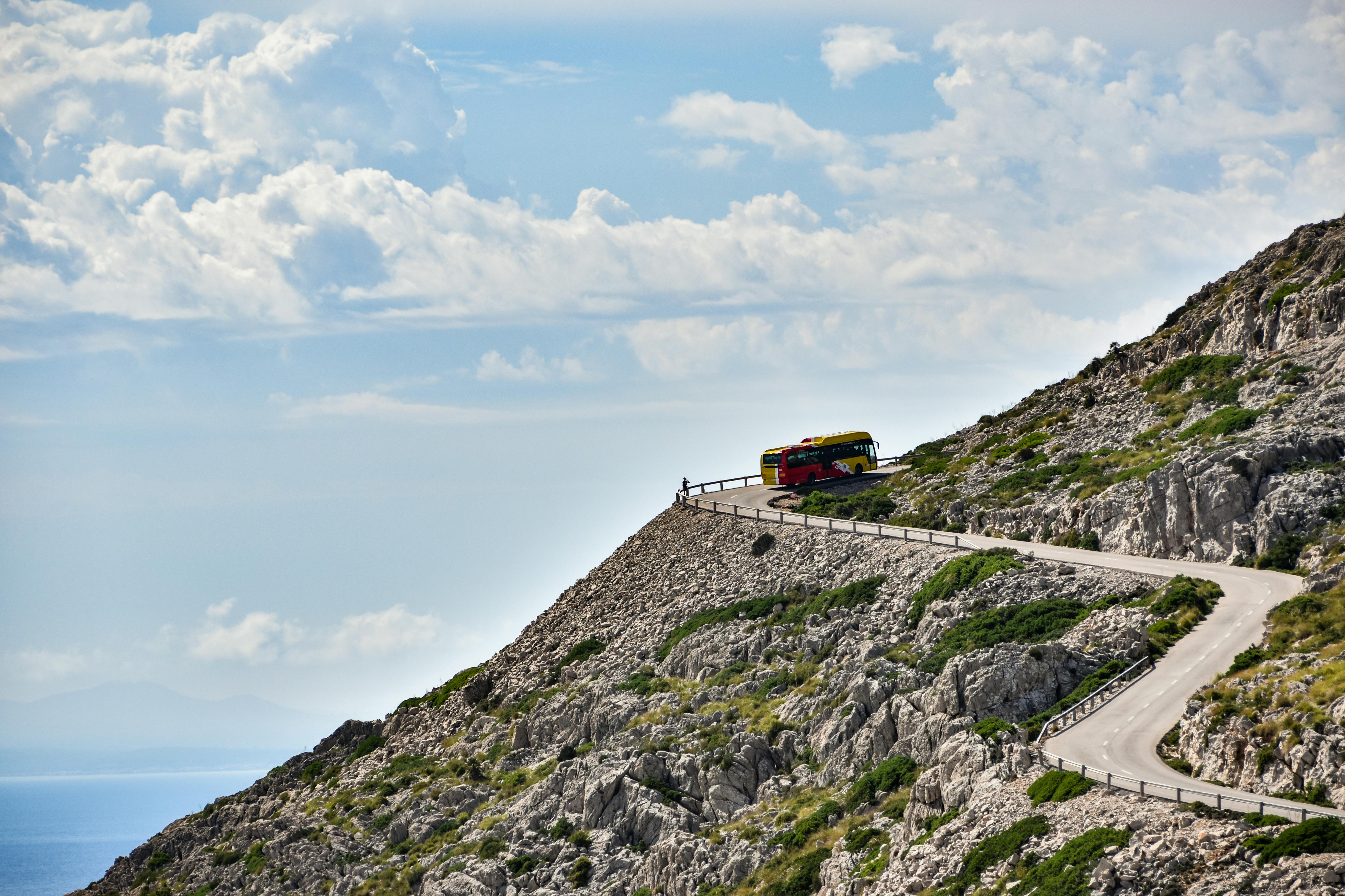 Bus Driving on a Narrow Cliff Road · Free Stock Photo