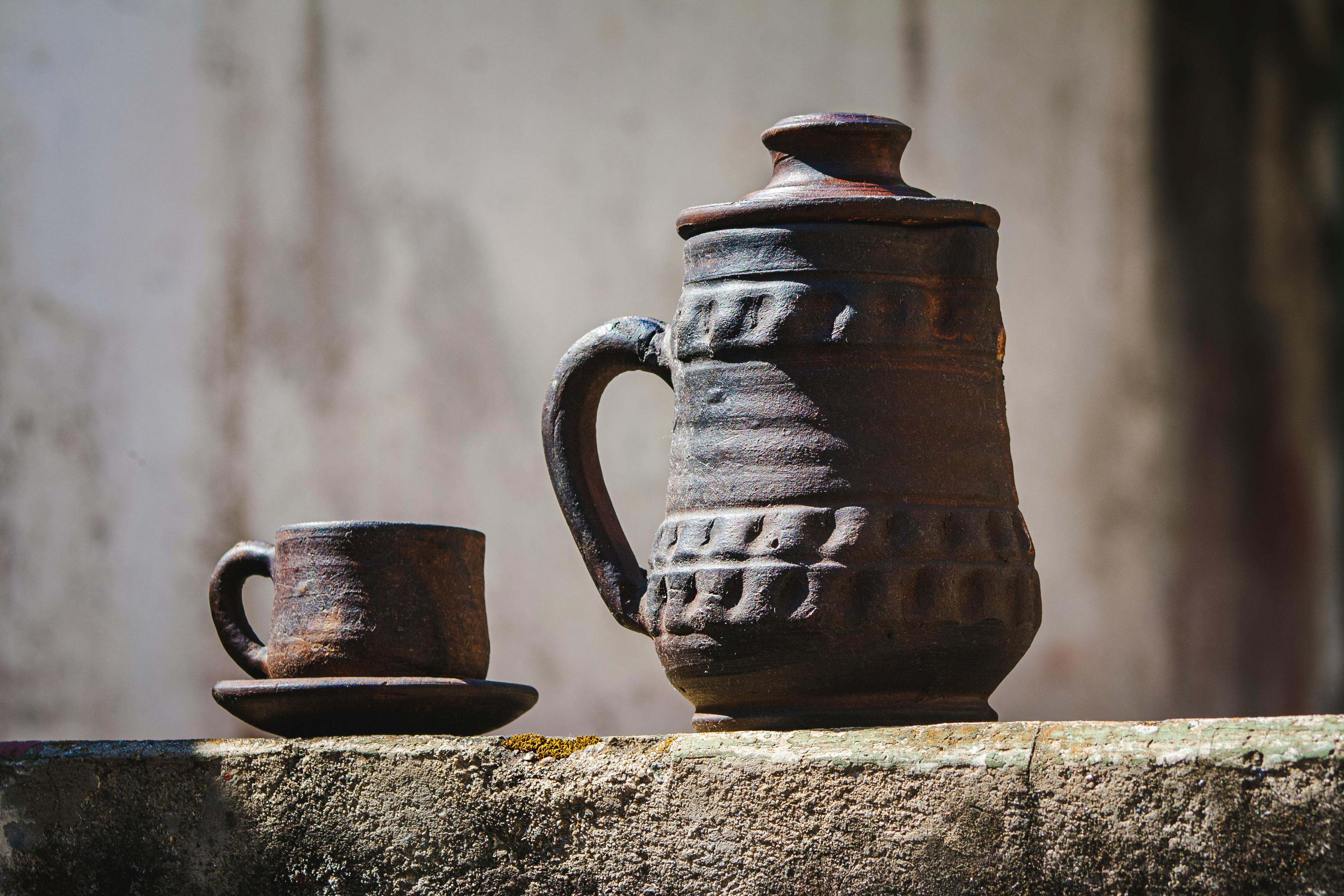 Ceramic Pitcher and Cup on Concrete Surface · Free Stock Photo