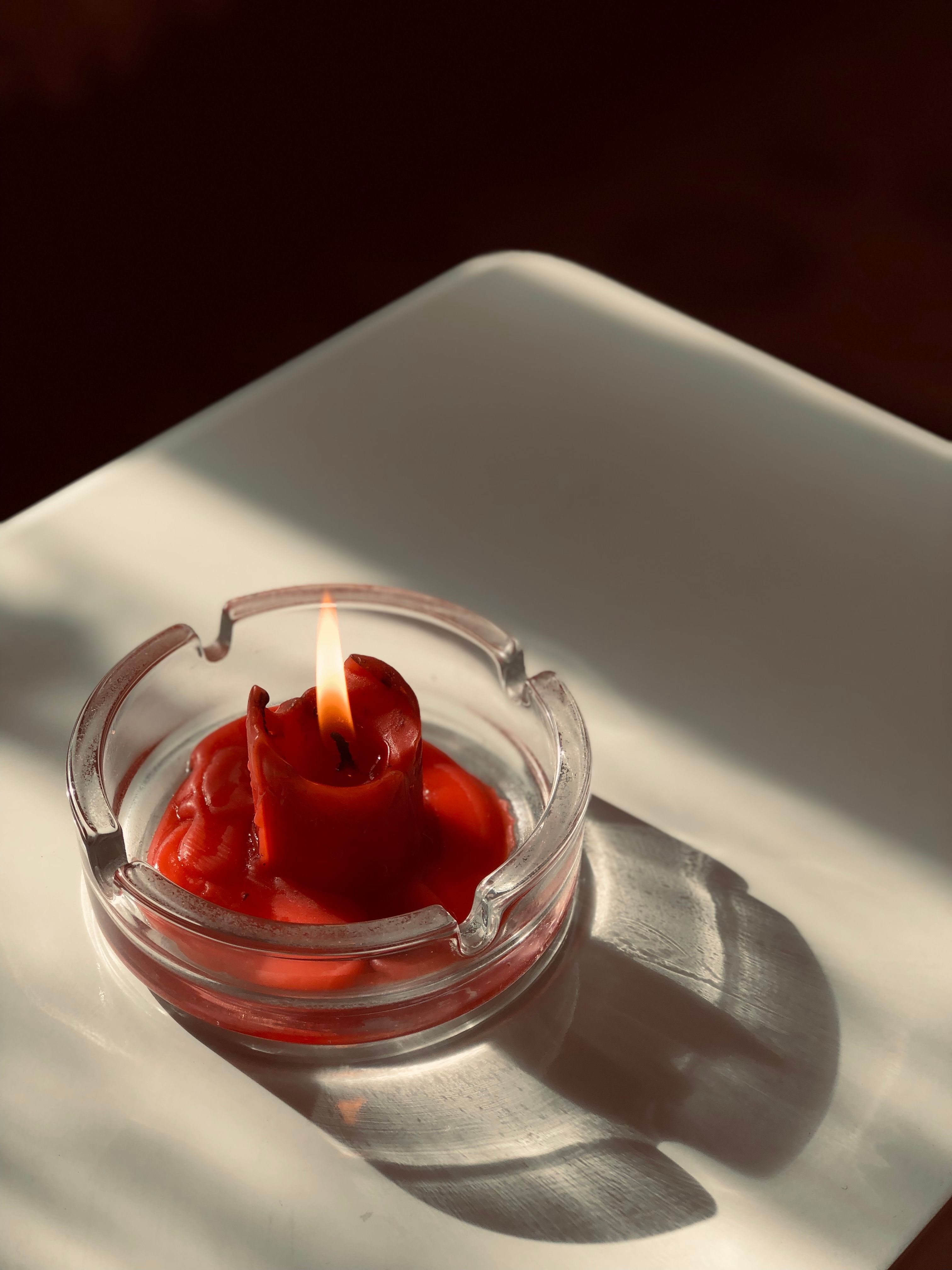 A Burning Candle in an Ashtray · Free Stock Photo