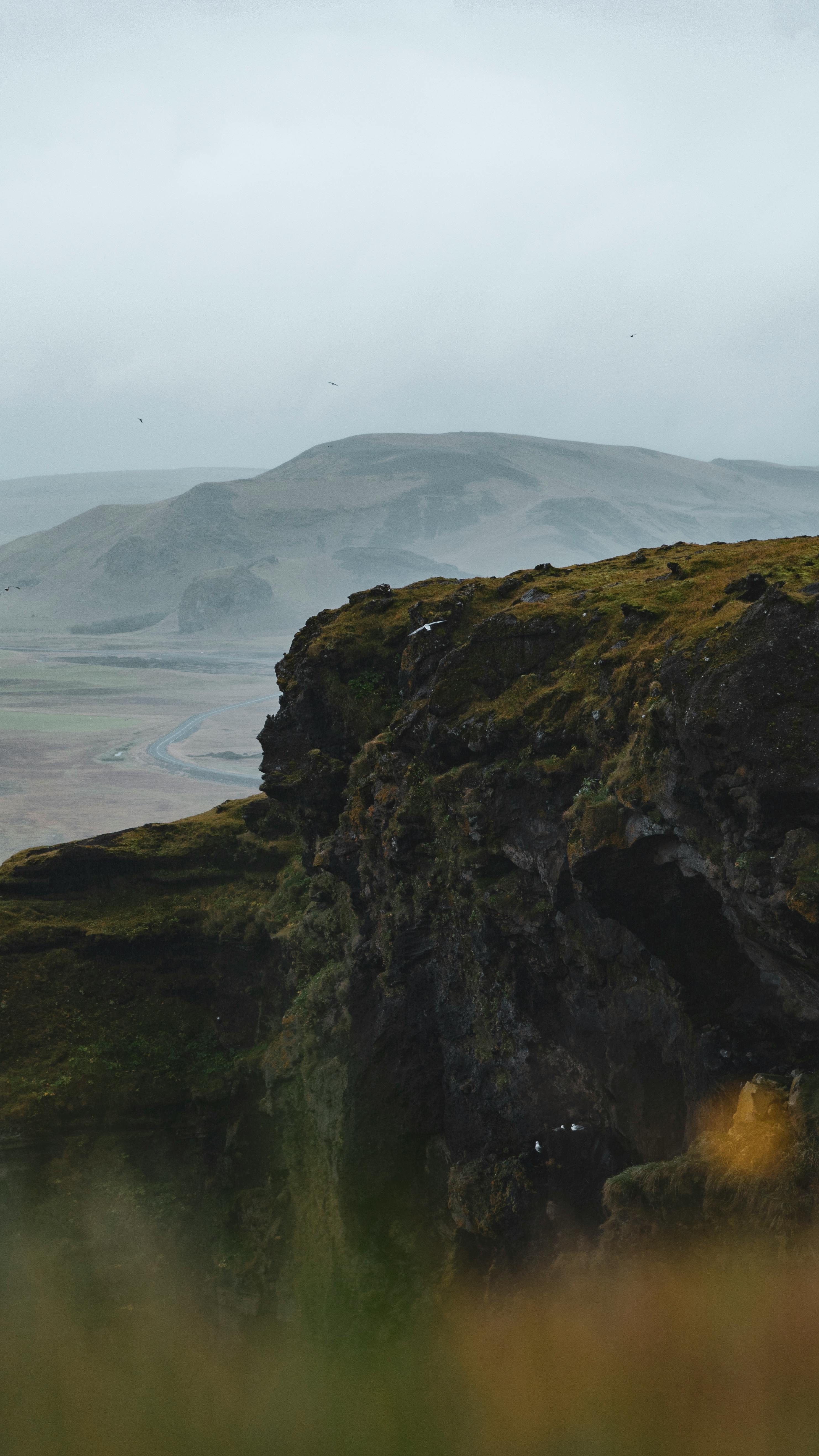 A Mossy Cliff Under Blue Sky · Free Stock Photo