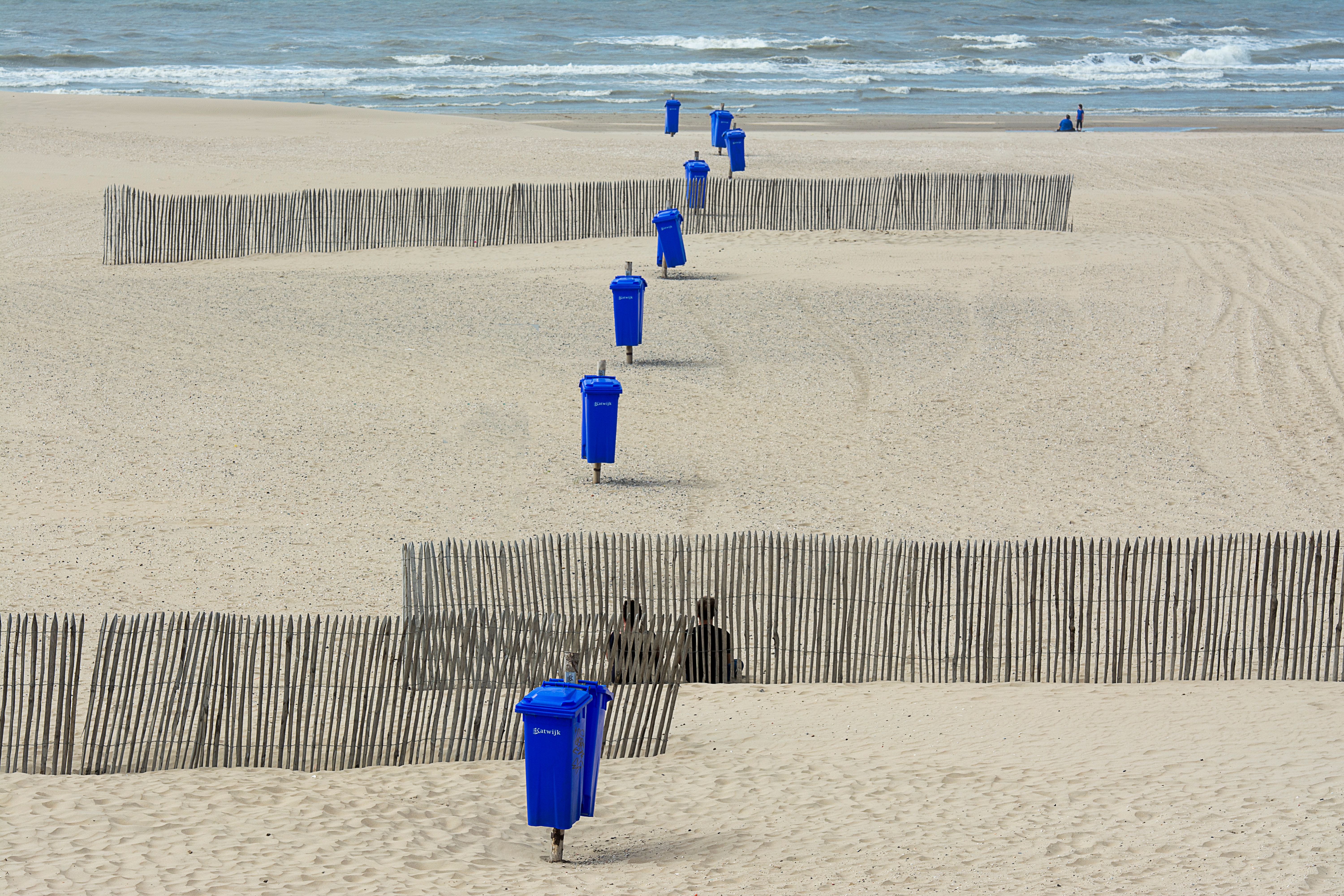 Blue Trash Bins on Shore · Free Stock Photo