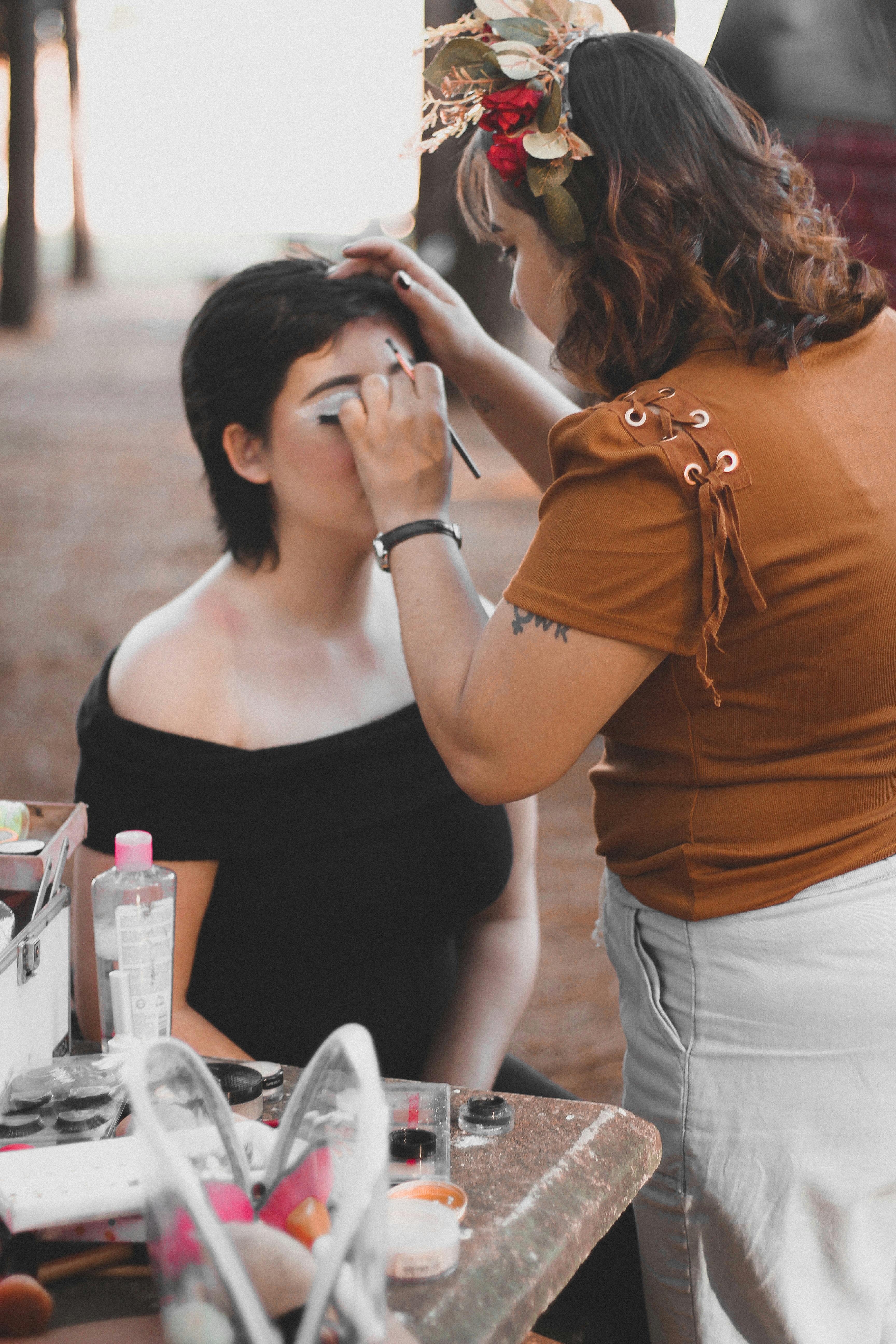 A Women Applying Makeup to Another Woman · Free Stock Photo