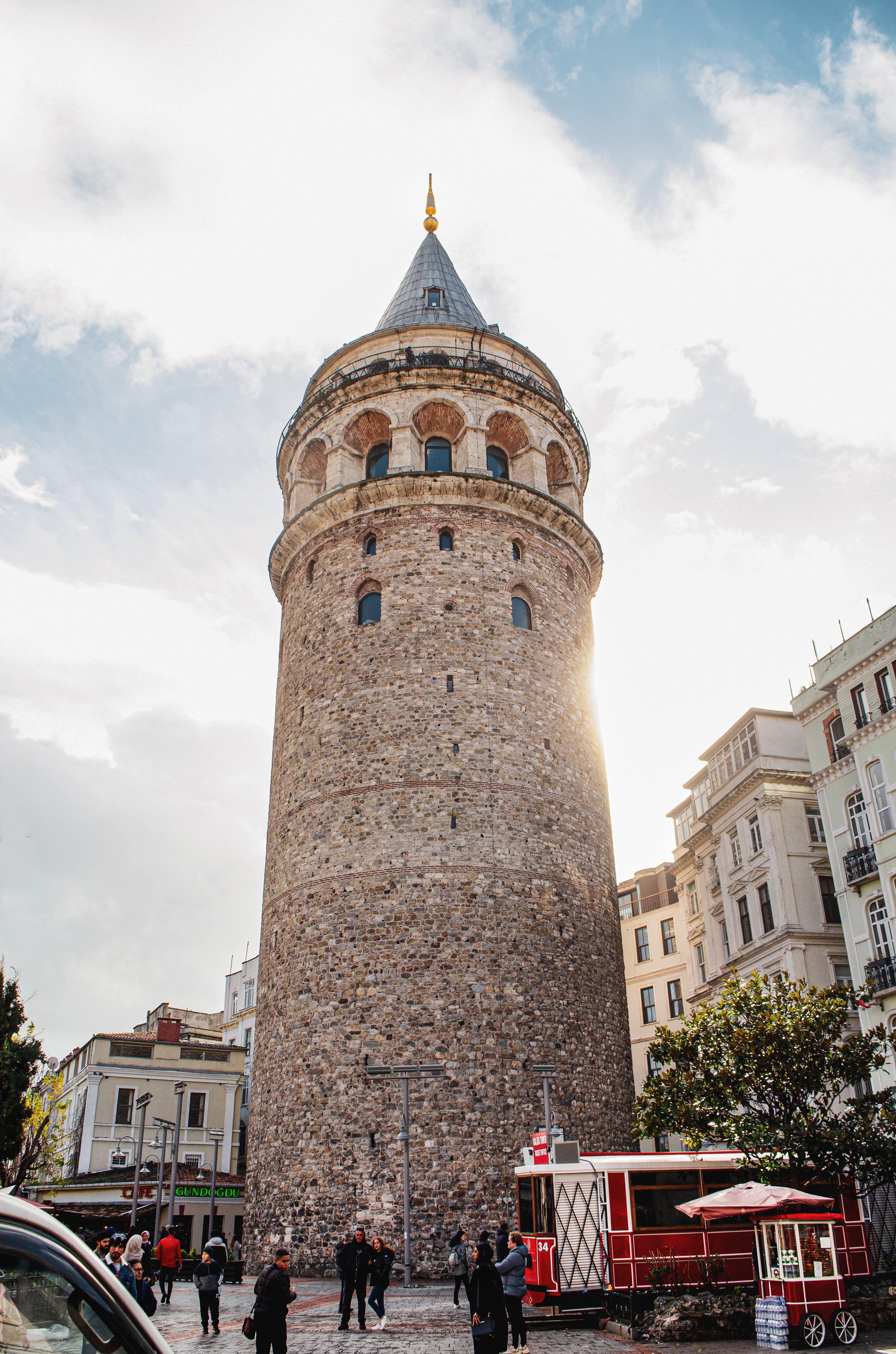 Cylindrical Brick Tower Under a Cloudy Blue Sky · Free Stock Photo