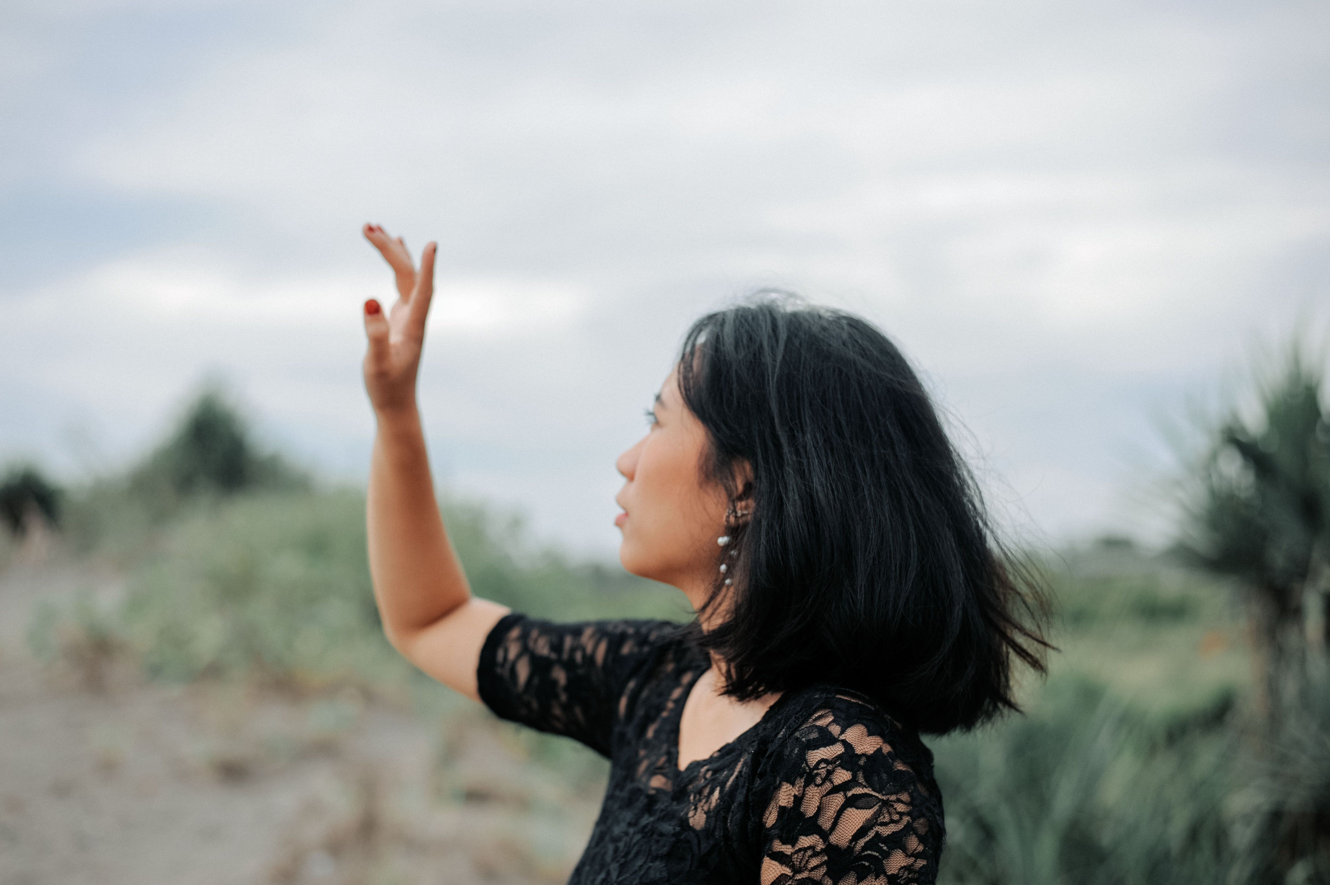 Woman with Her Hand Raised · Free Stock Photo