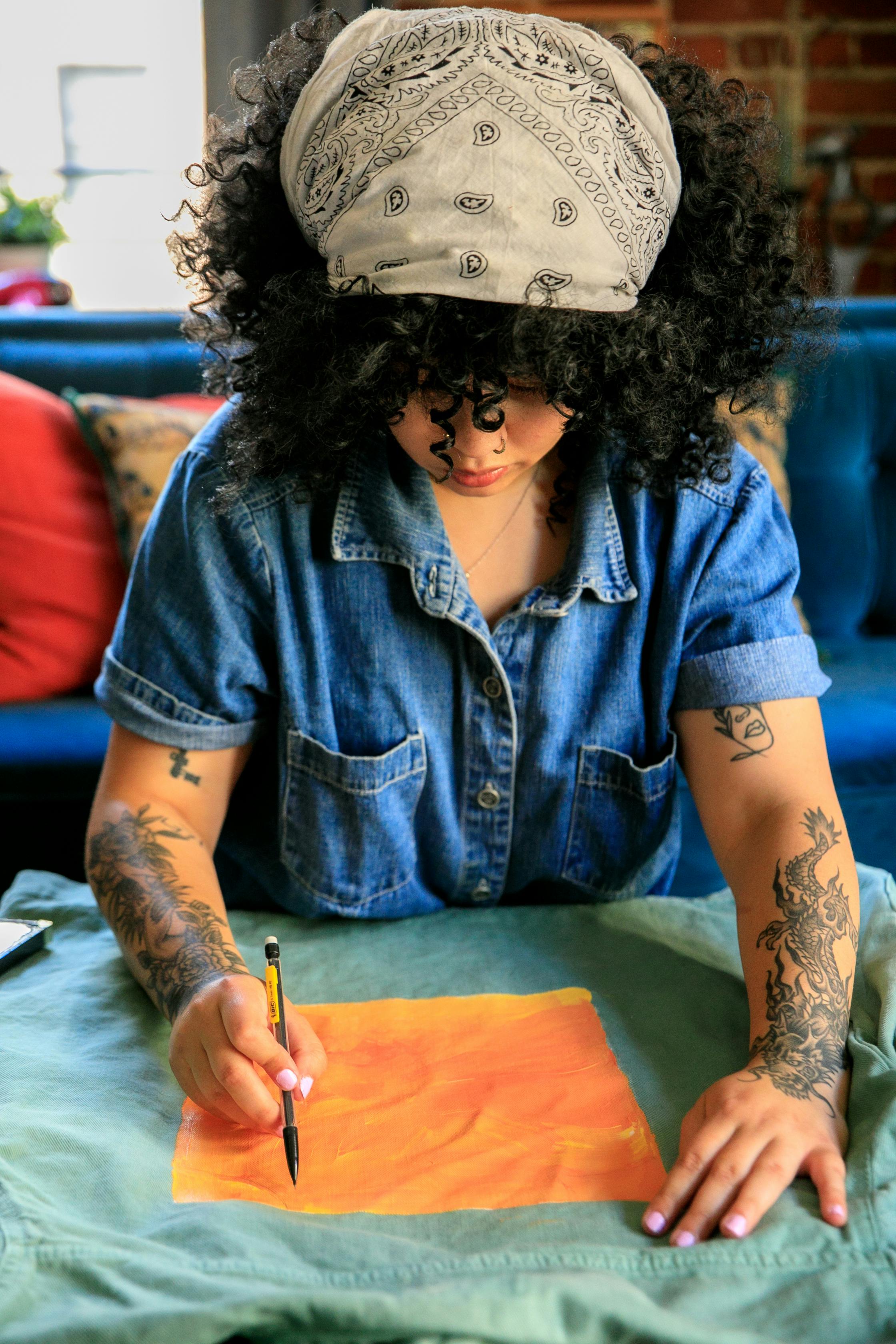 Woman Painting on Fabric on Table · Free Stock Photo